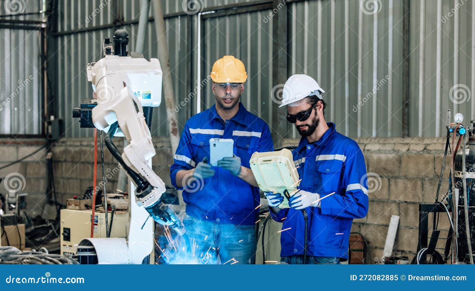 Two Highly Competent Robotic Operators Collaborate To Configure New Automation Stock Image ...