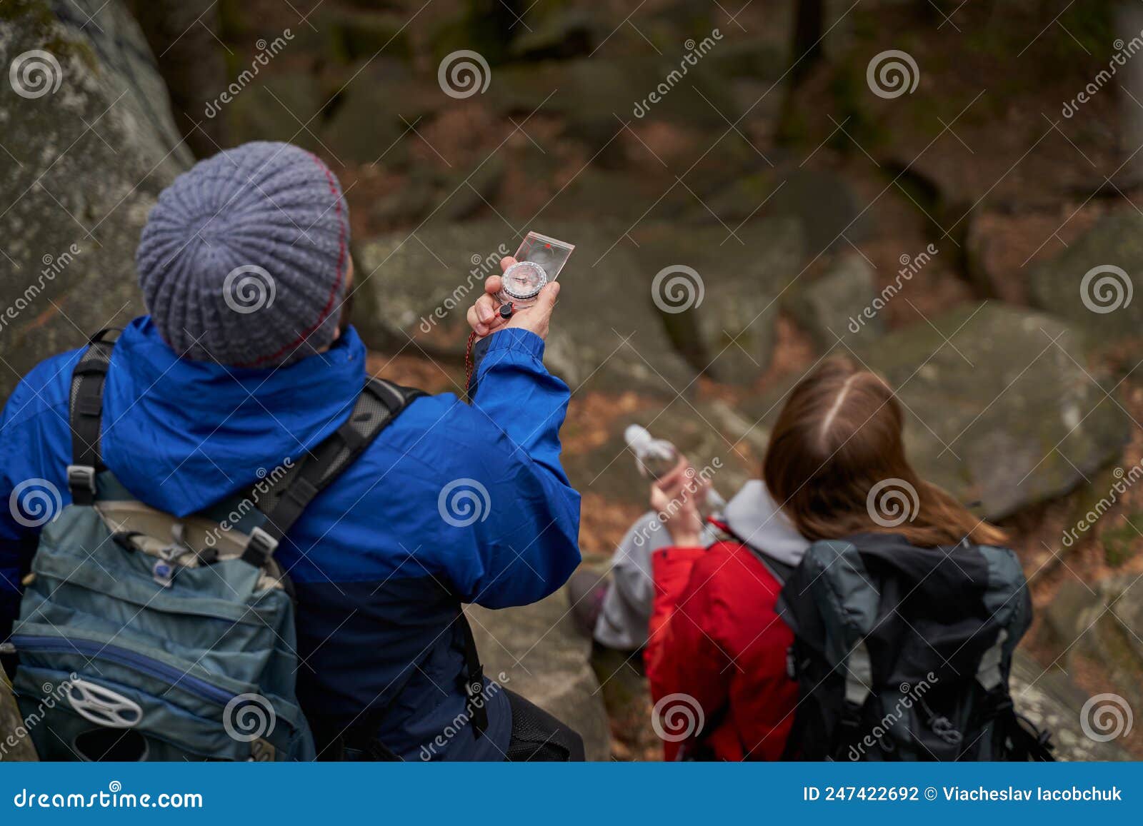 Two Hikers Determining Location in Woods with Compass Stock Photo ...