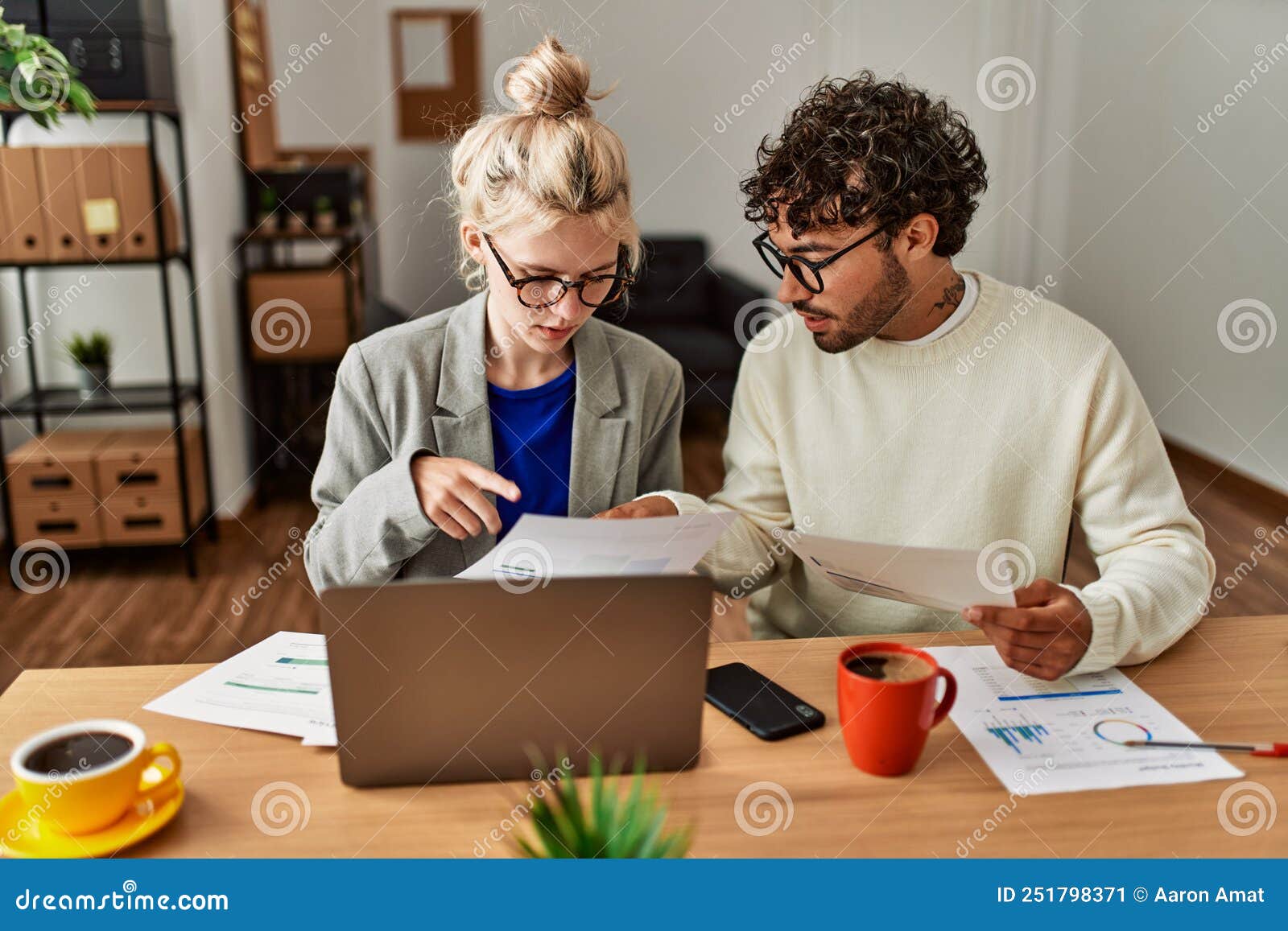 Two Hispanic Business Workers Concentrated Working at the Office Stock ...