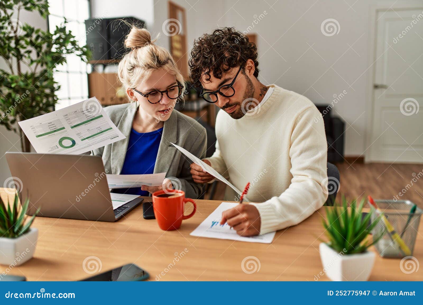 Two Hispanic Business Workers Concentrated Working at the Office Stock ...