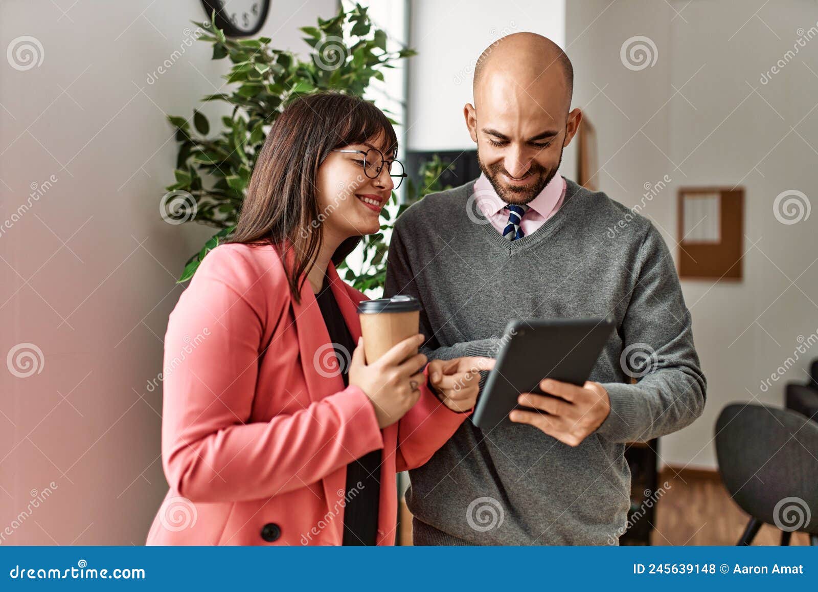Two Hispanic Business Workers Working Using Laptop and Drinking Coffee ...