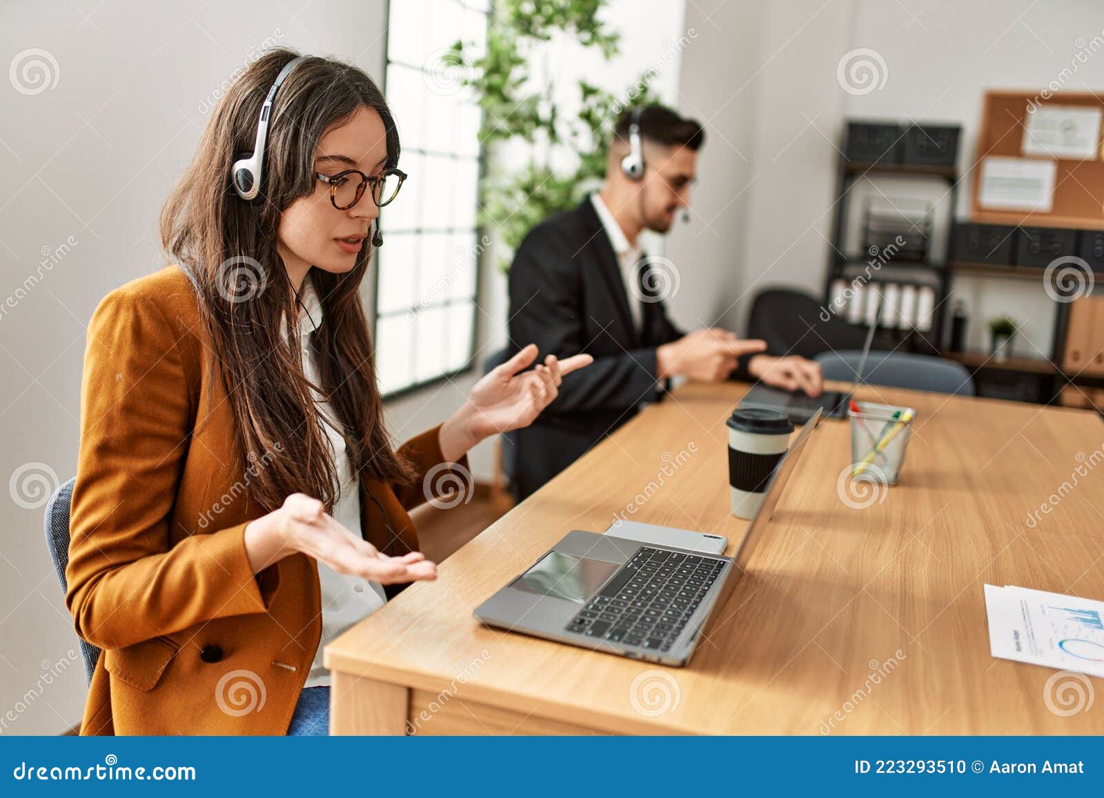 Two Hispanic Call Center Agents Working at the Office Stock Photo ...