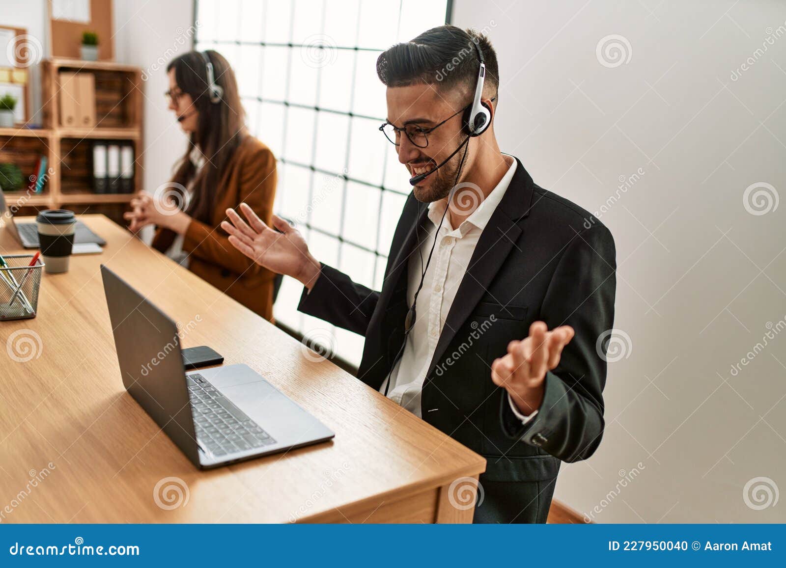 Two Hispanic Call Center Agents Working at the Office Stock Photo ...