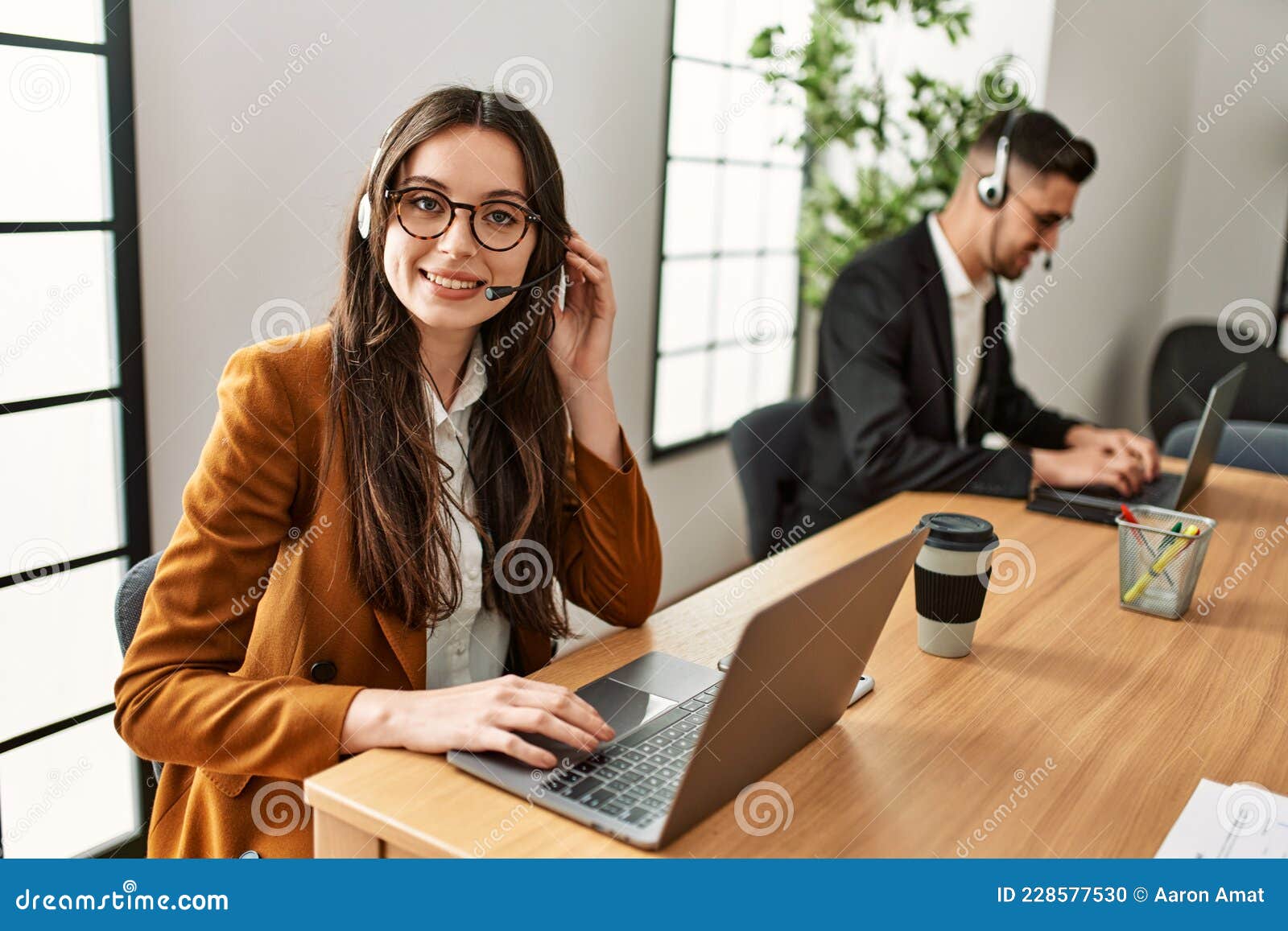 Two Hispanic Call Center Agents Working at the Office Stock Photo ...