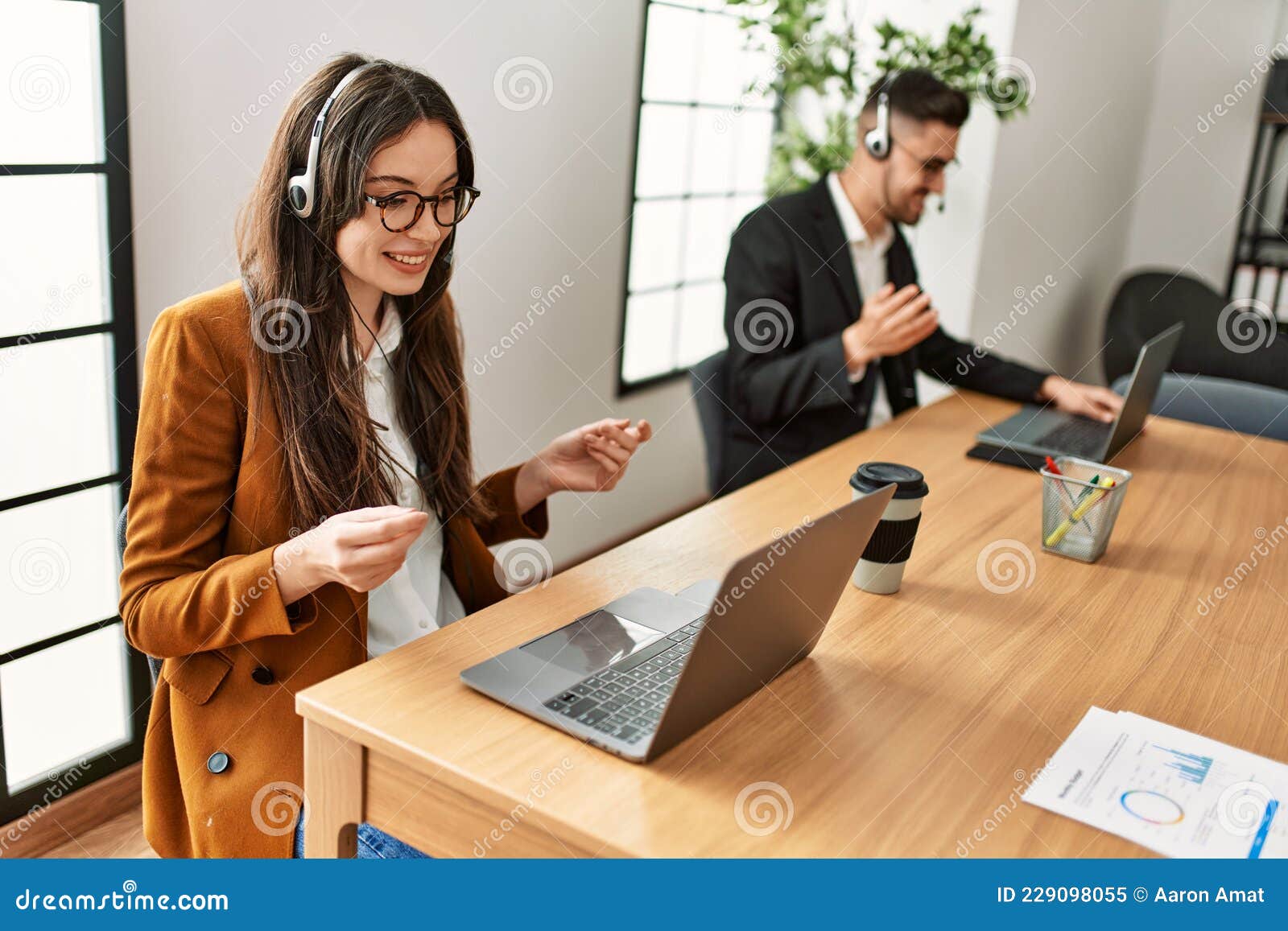 Two Hispanic Call Center Agents Working at the Office Stock Image ...