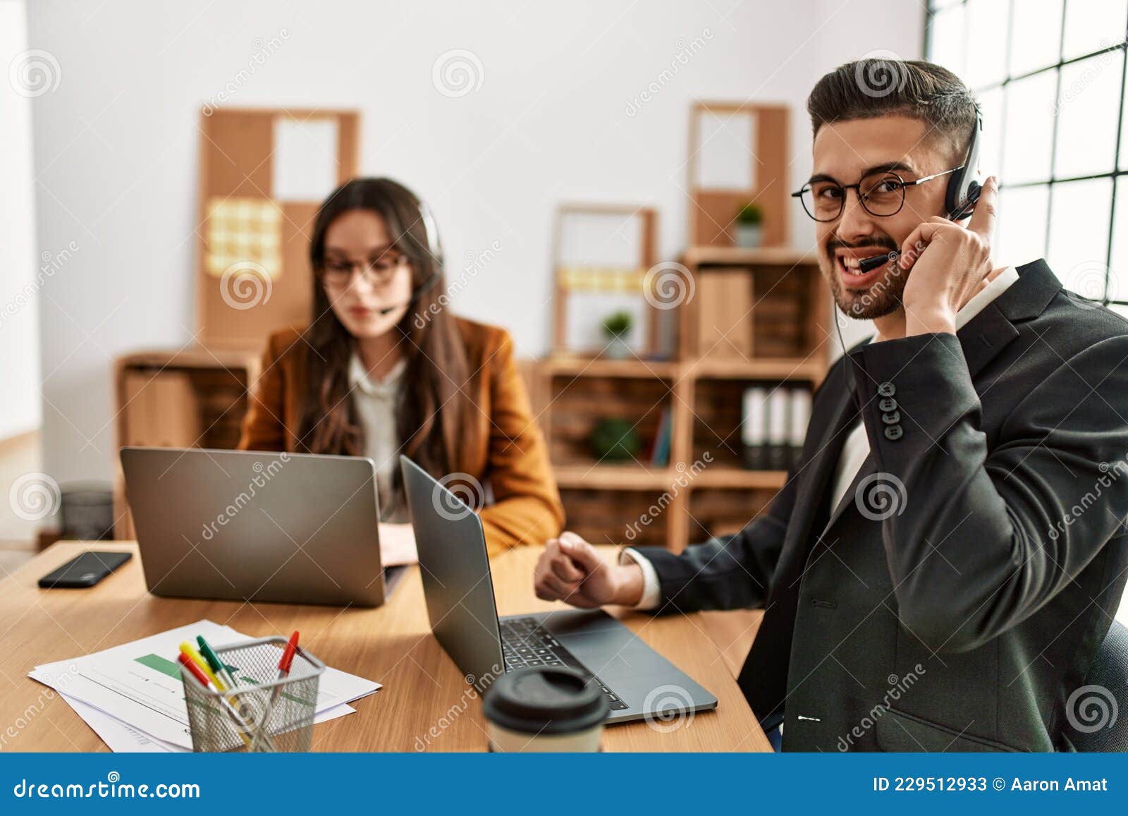 Two Hispanic Call Center Agents Working at the Office Stock Image ...