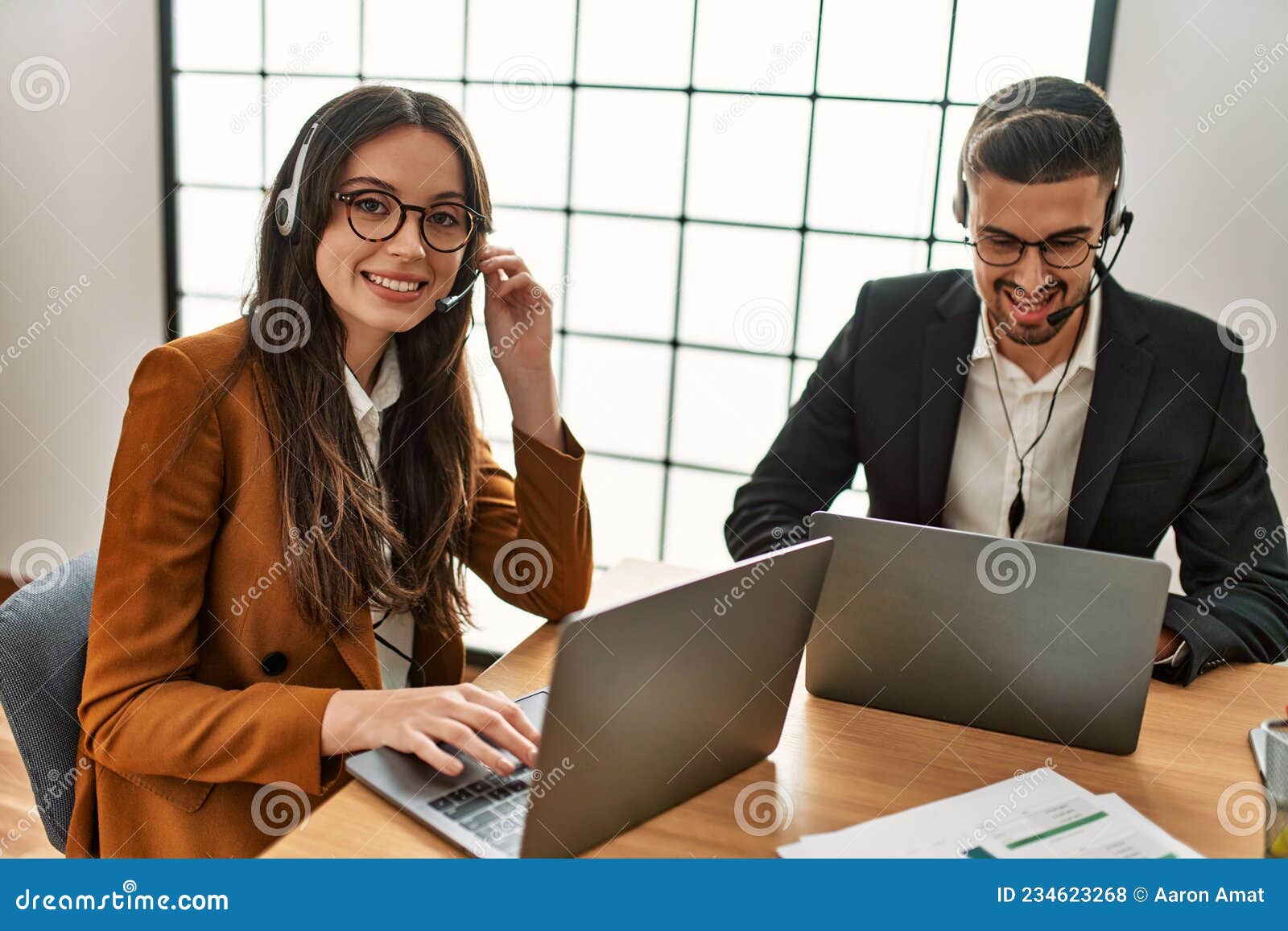 Two Hispanic Call Center Agents Working at the Office Stock Photo ...