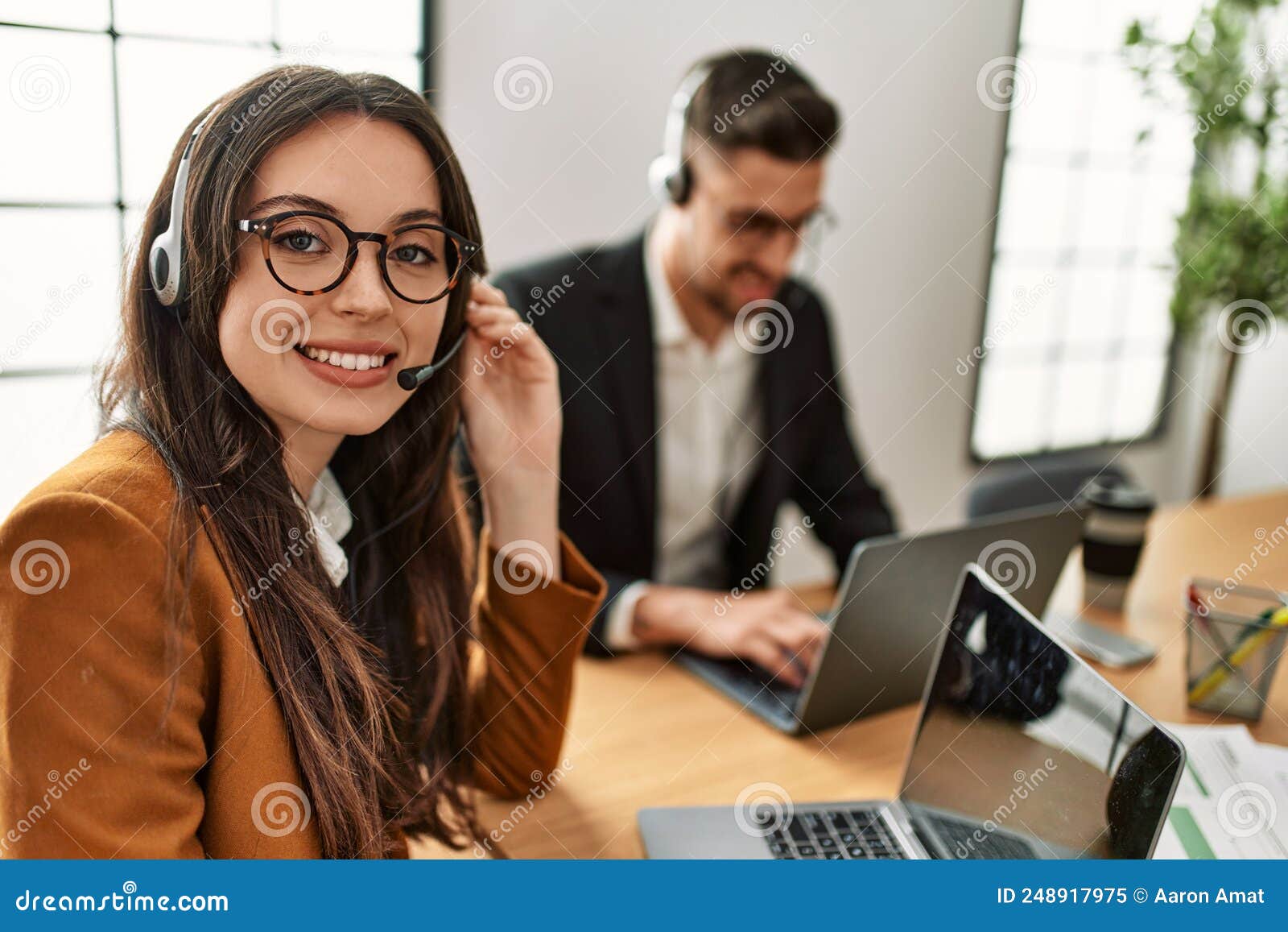 Two Hispanic Call Center Agents Working at the Office Stock Image ...