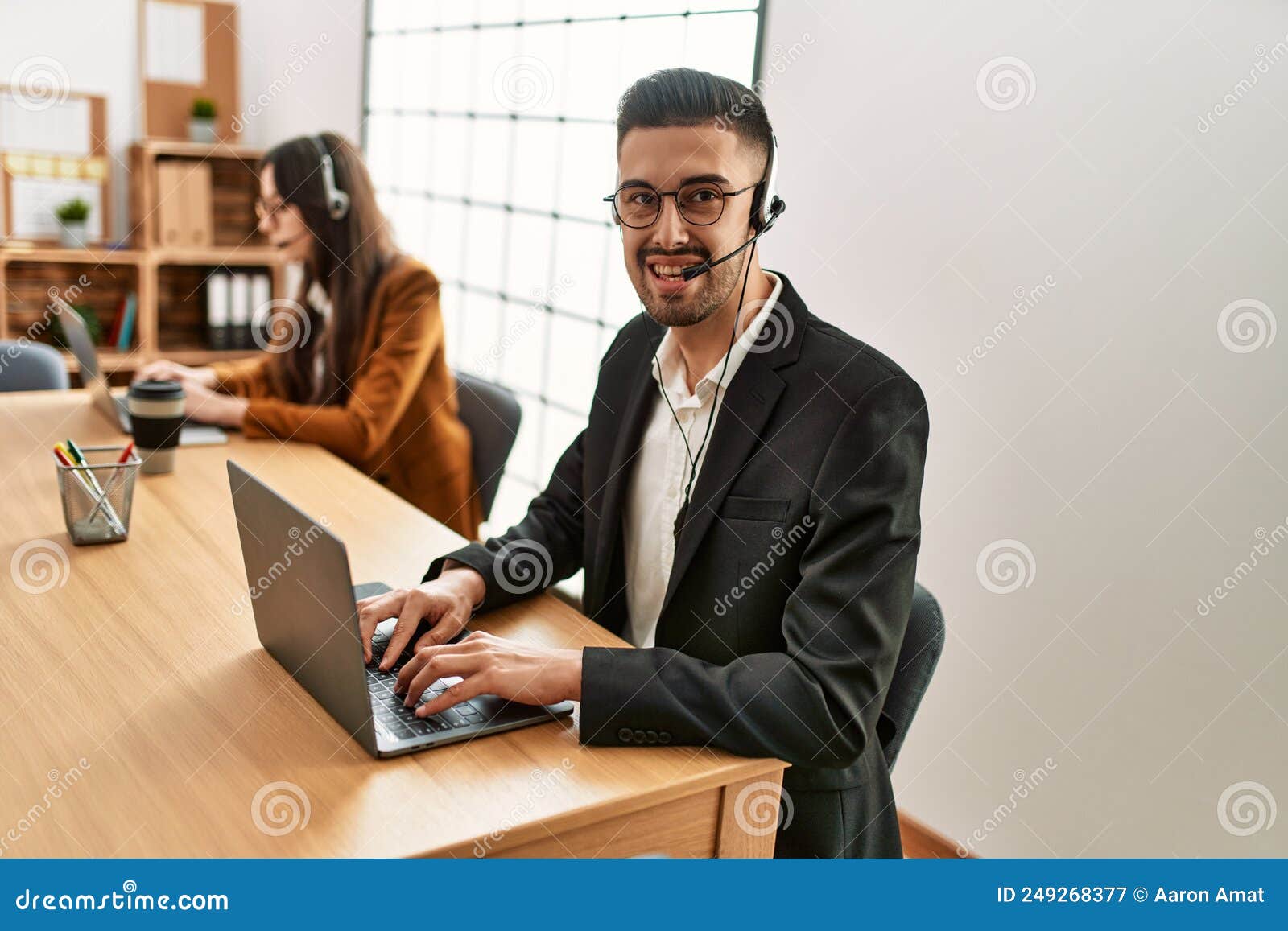 Two Hispanic Call Center Agents Working at the Office Stock Image ...