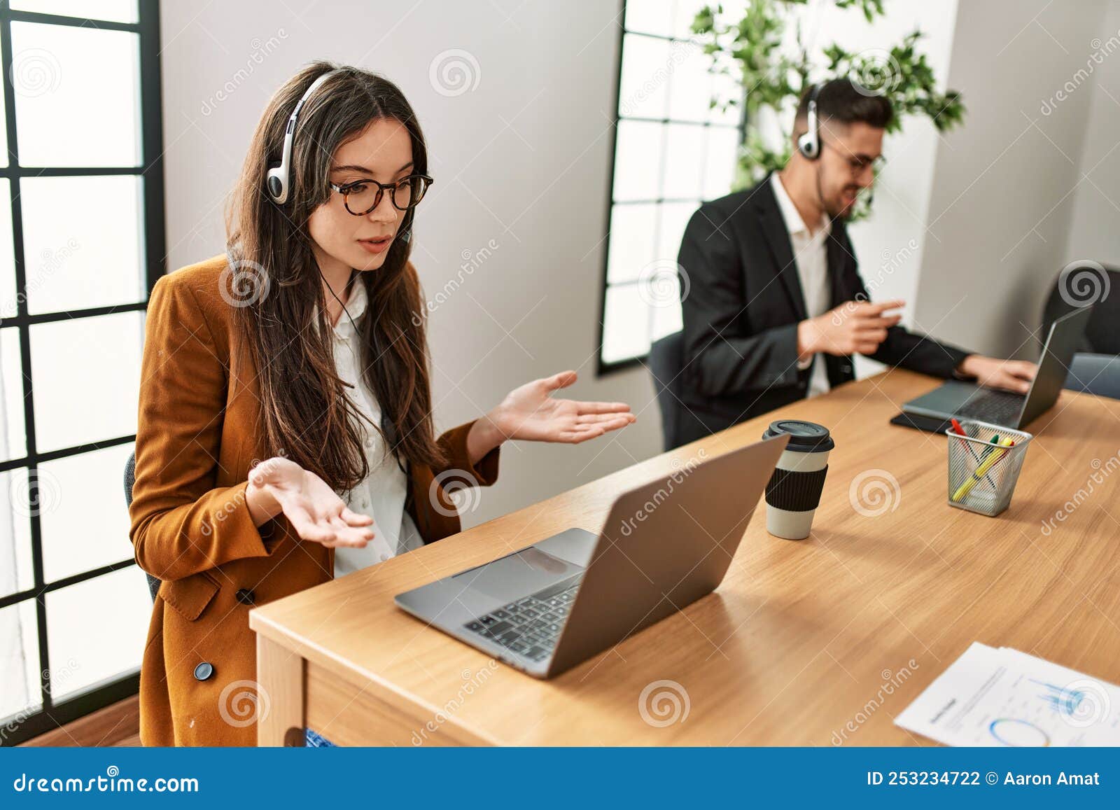 Two Hispanic Call Center Agents Working at the Office Stock Photo ...