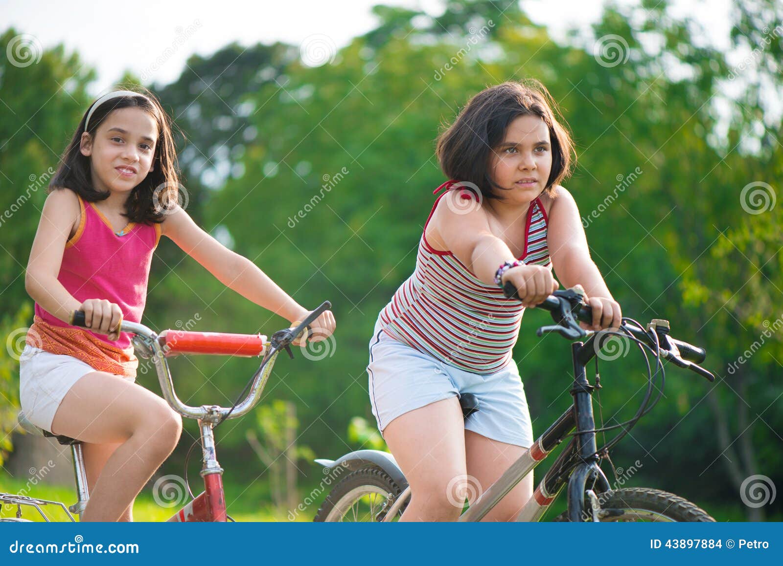 Two Hispanic Children Riding on Bikes Stock Photo - Image of cycling ...