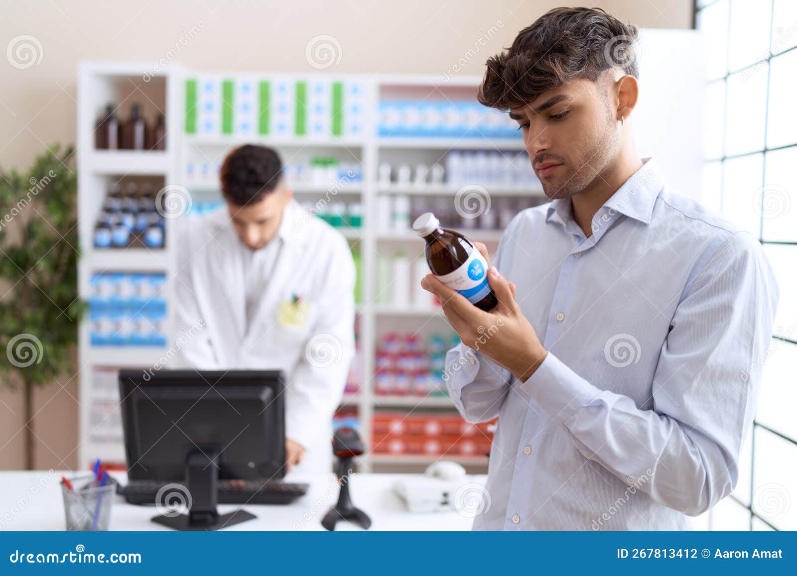 Two Hispanic Men Pharmacist and Client Using Computer Reading ...