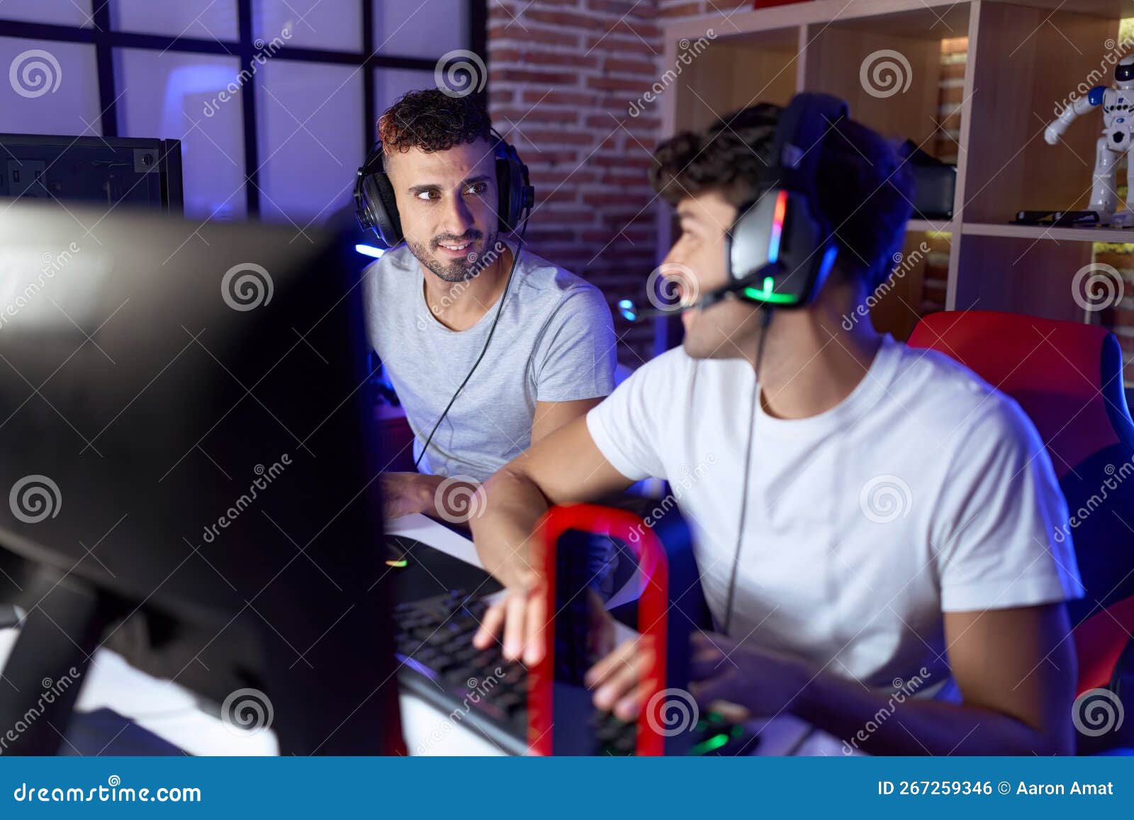 Two Hispanic Men Streamers Playing Video Game Using Computer at Gaming ...