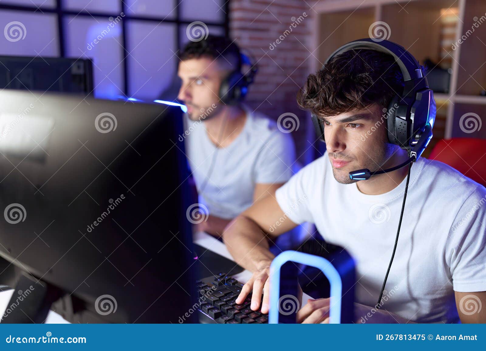 Two Hispanic Men Streamers Playing Video Game Using Computer at Gaming ...