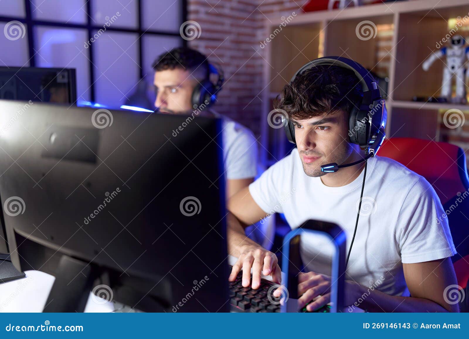 Two Hispanic Men Streamers Playing Video Game Using Computer at Gaming ...