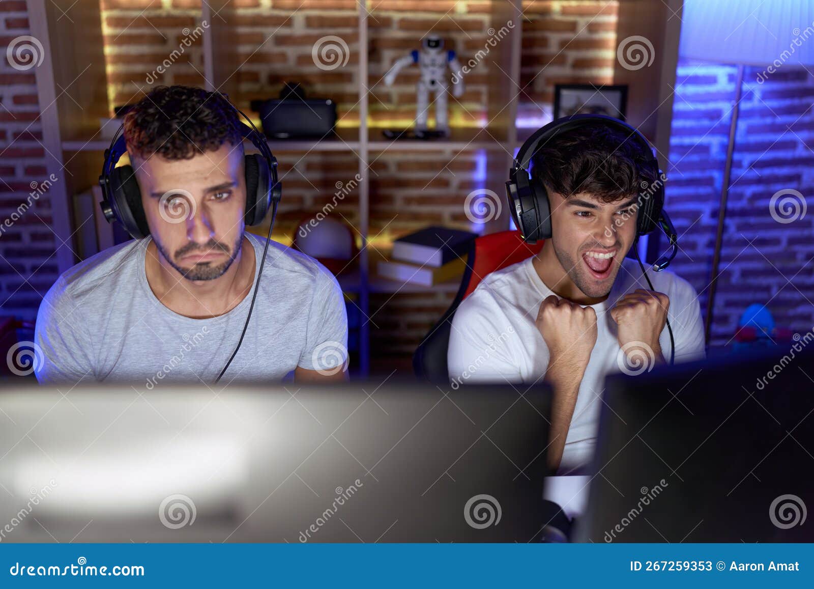 Two Hispanic Men Streamers Playing Video Game with Winner Expression at ...
