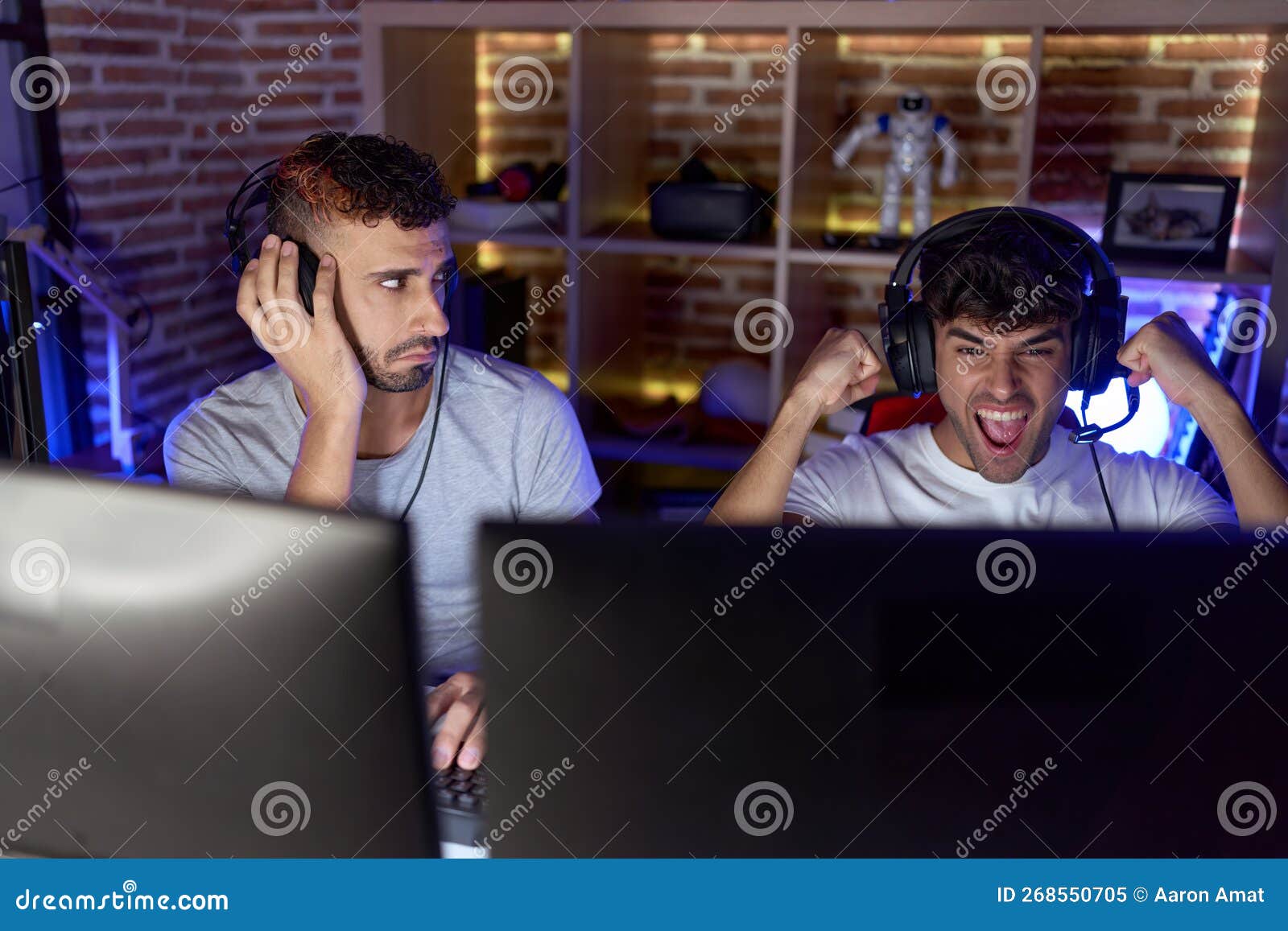 Two Hispanic Men Streamers Playing Video Game with Winner Expression at ...