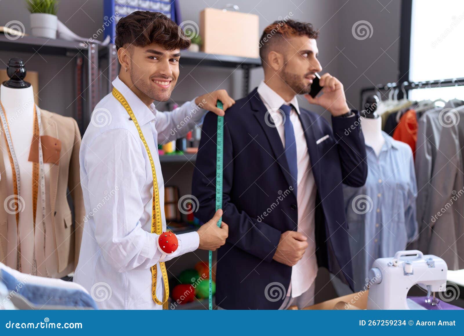 Two Hispanic Men Tailor Measuring Sleeve Jacket while Client Talk on ...