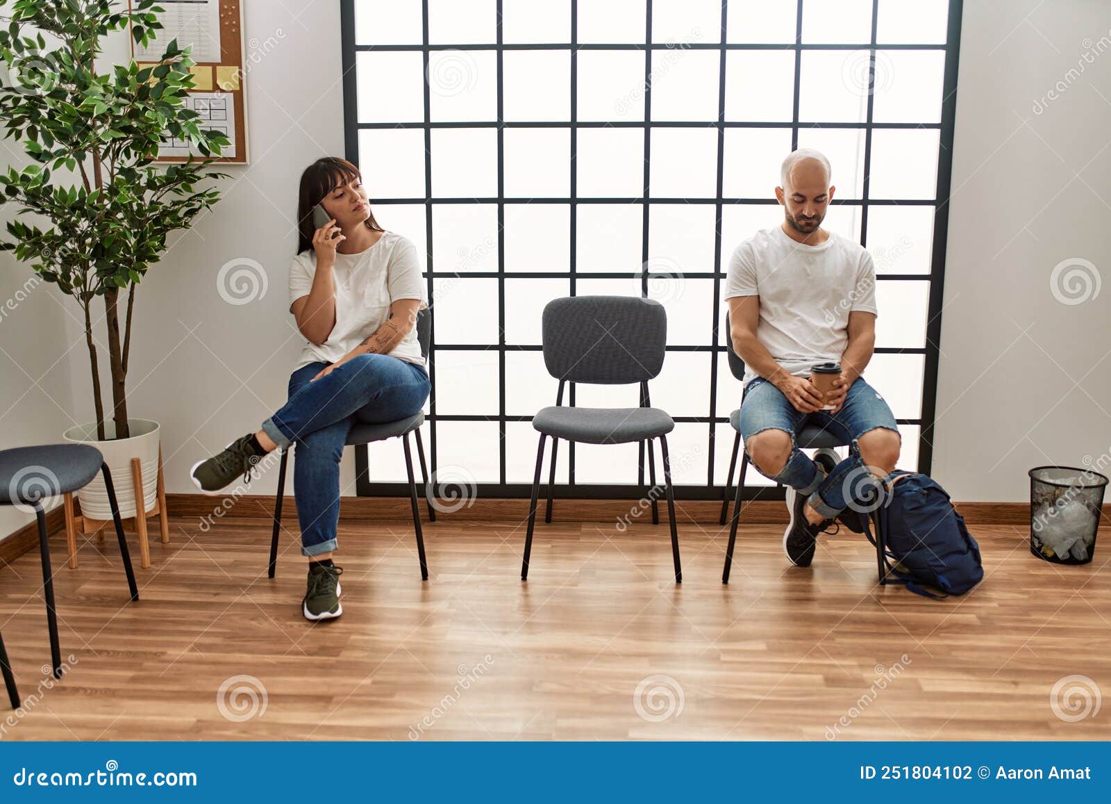 Two Hispanic Person Boring Talking on the Smartphone at Waiting Room ...