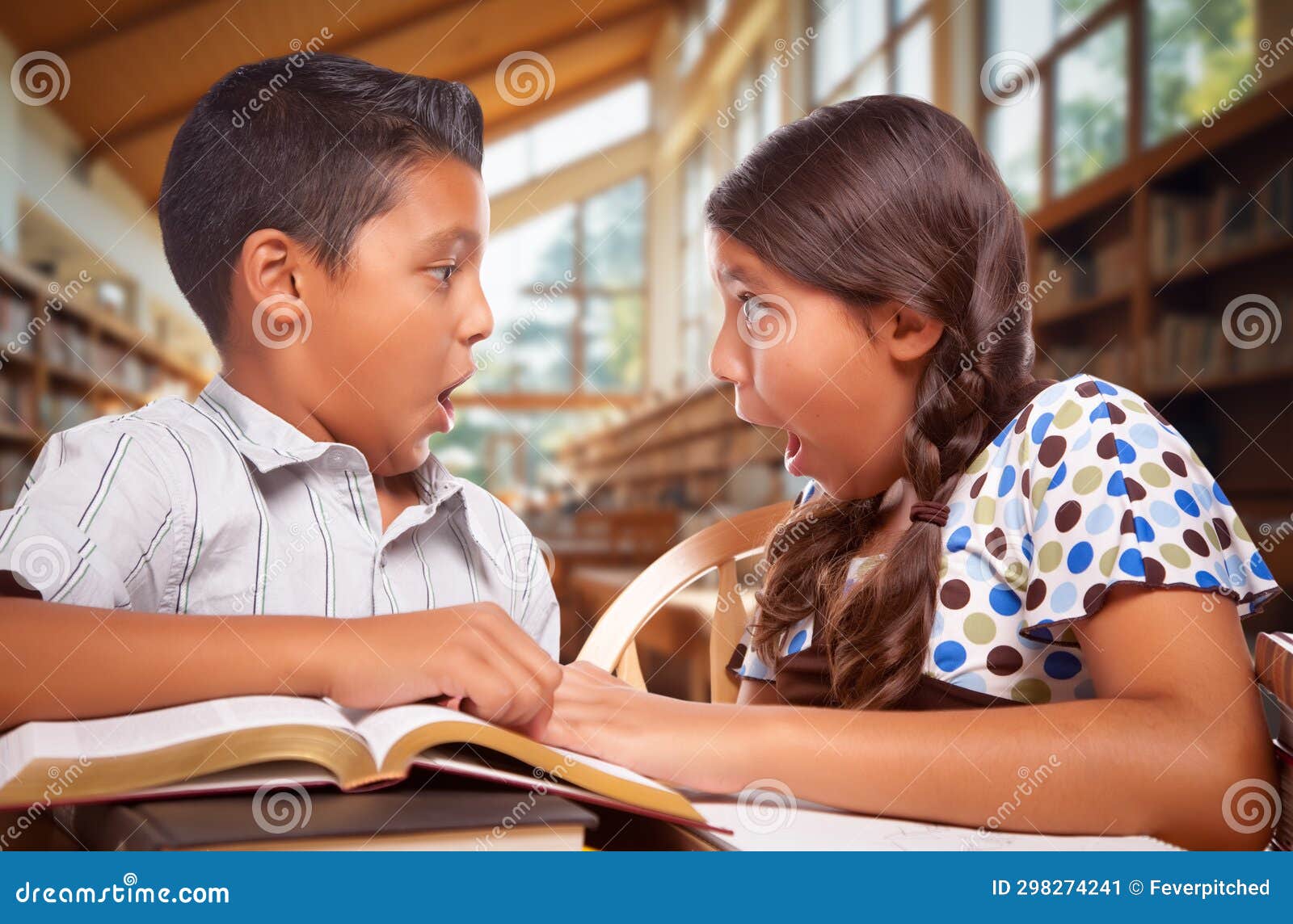 Two Hispanic School Kids in a Library with a Shocked Expression on ...