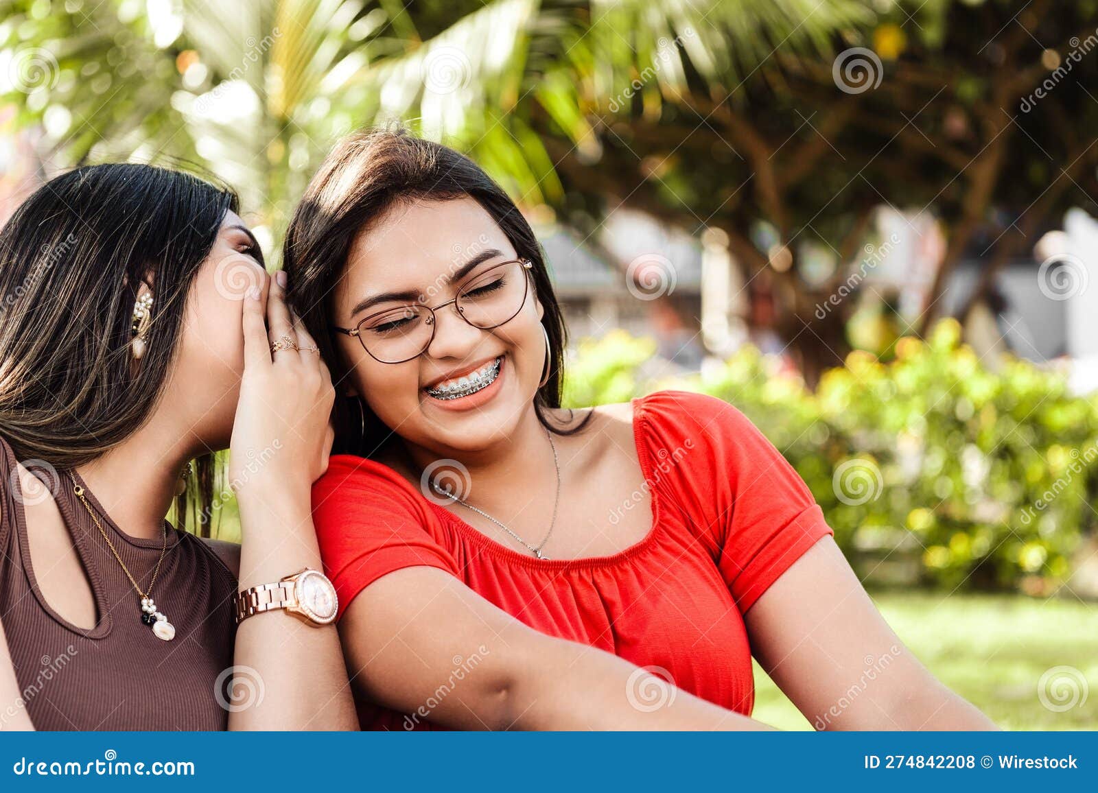 Two Hispanic Smiling Girls Having a Conversation in a Park. Stock Photo ...