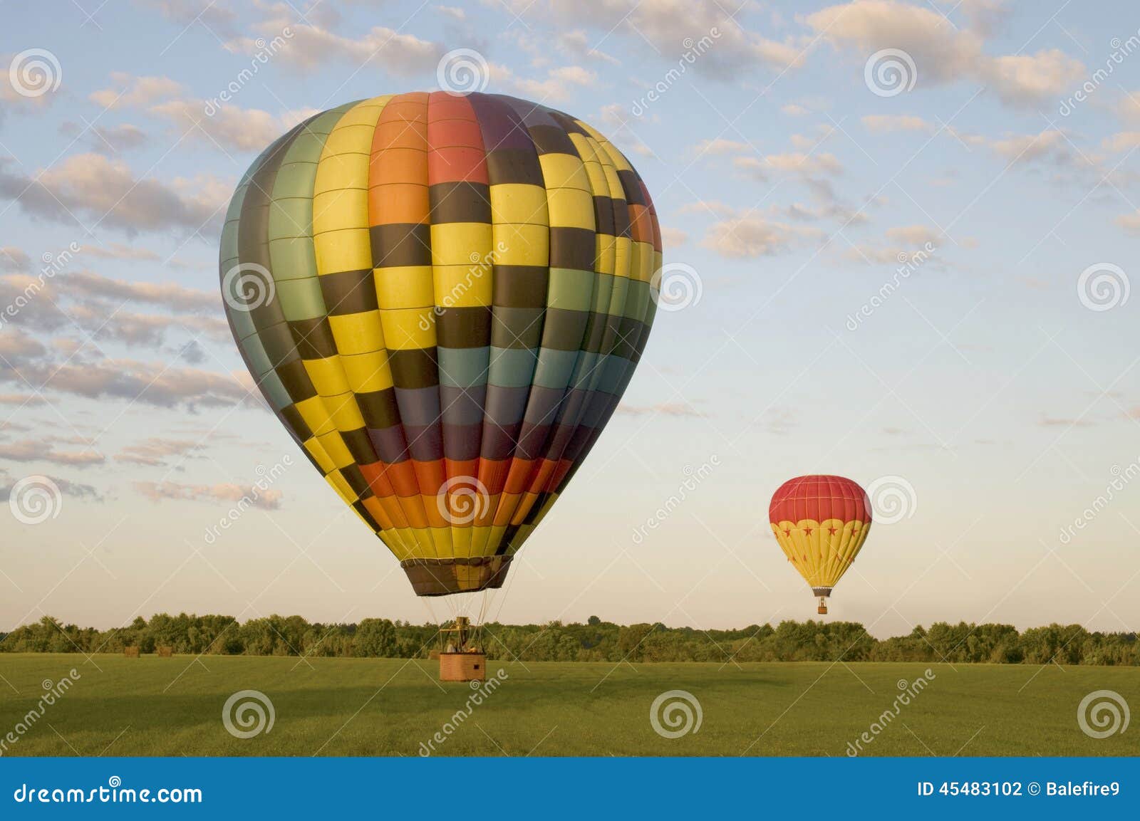 Two Hot-air Balloons in a Field Stock Photo - Image of hobby, flight ...