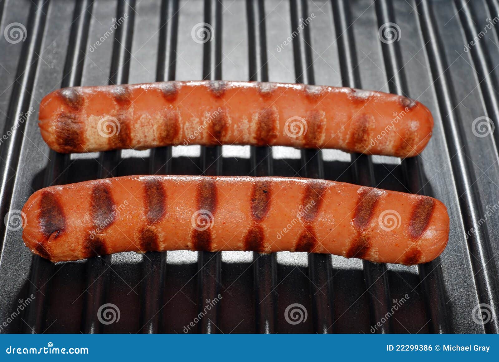 Two hotdogs on a grill stock photo. Image of sizzle, grill - 22299386