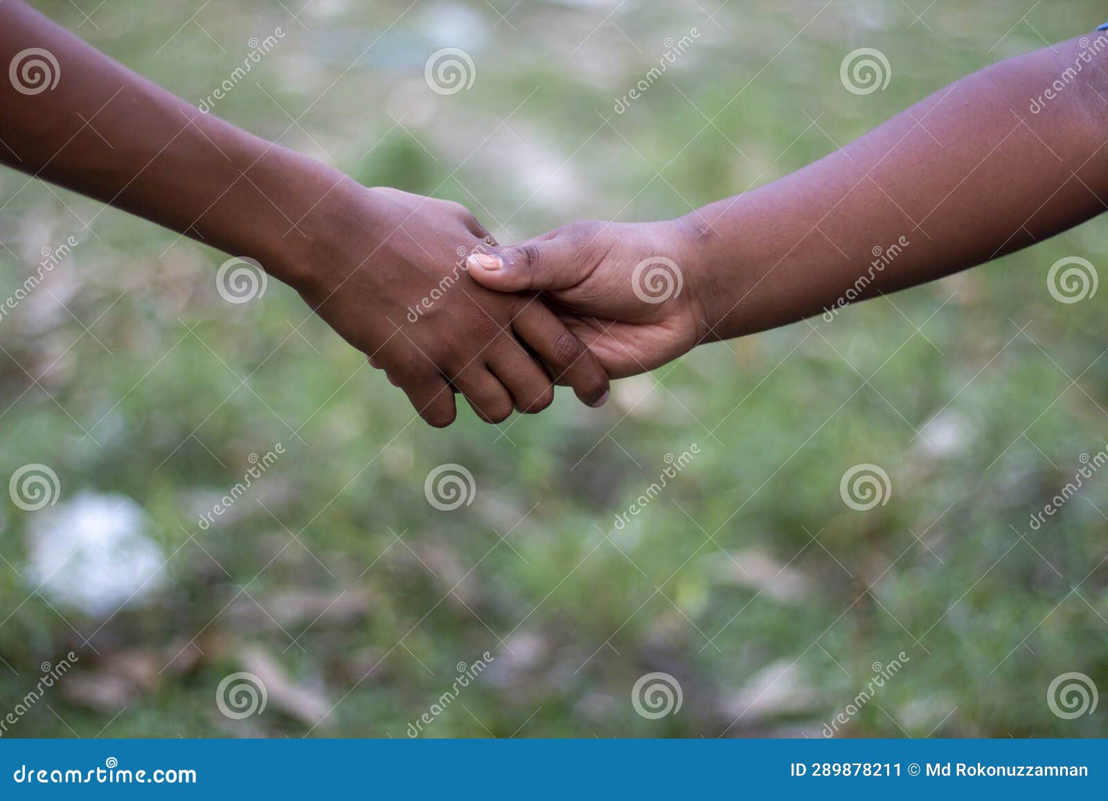 Two Human Hands Joined Together in Partnership and the Background Blur ...