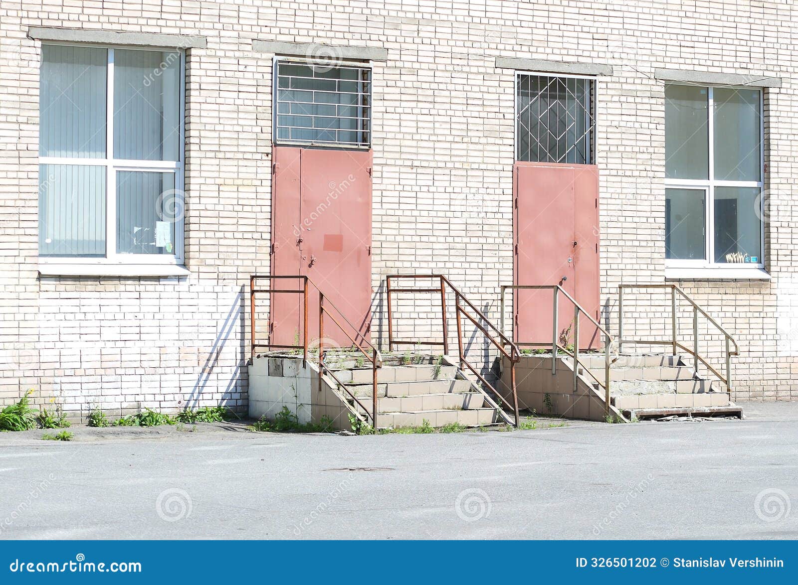 Two Identical Entrances with a Porch and Steps To a Brick Building ...