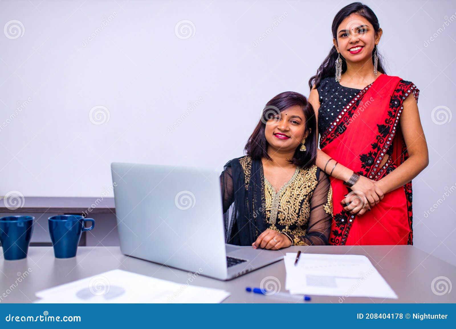 Two Indian Colleages Discussing Ideas Using a Tablet Computer at the ...