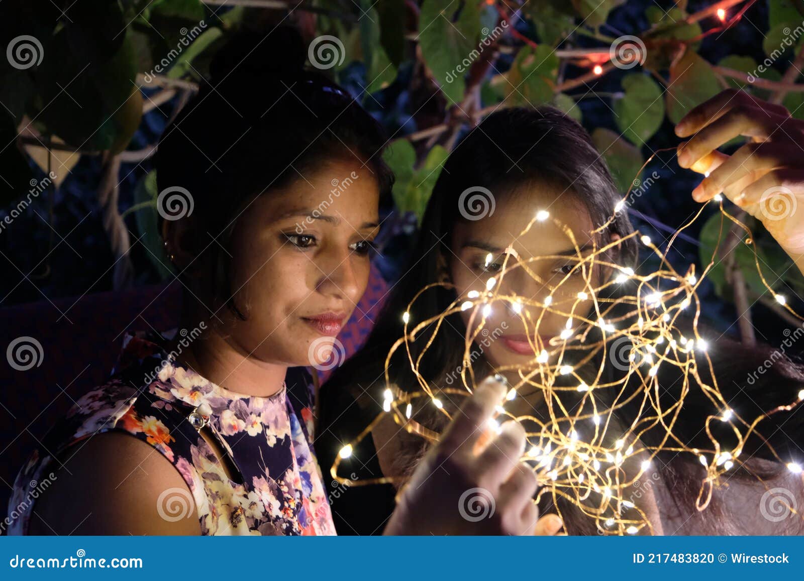 Indian Female Friends Holding Illuminated String Lights in the Evening ...