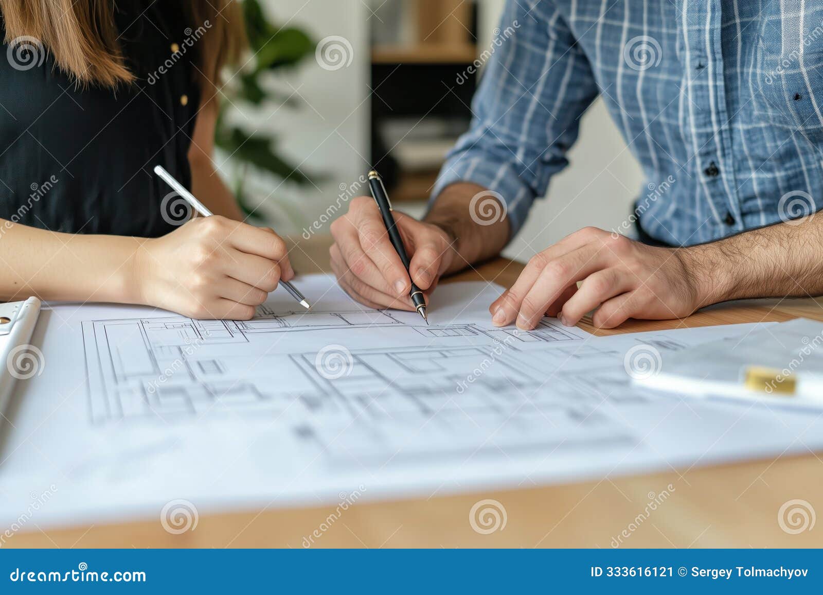 Collaborative Design Session in an Office with Two Individuals Drafting ...
