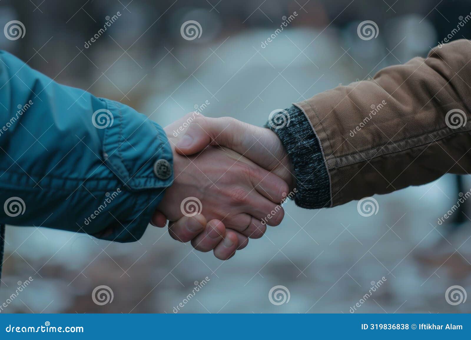 Two Individuals Making a Handshake Gesture while Standing in a Snowy ...