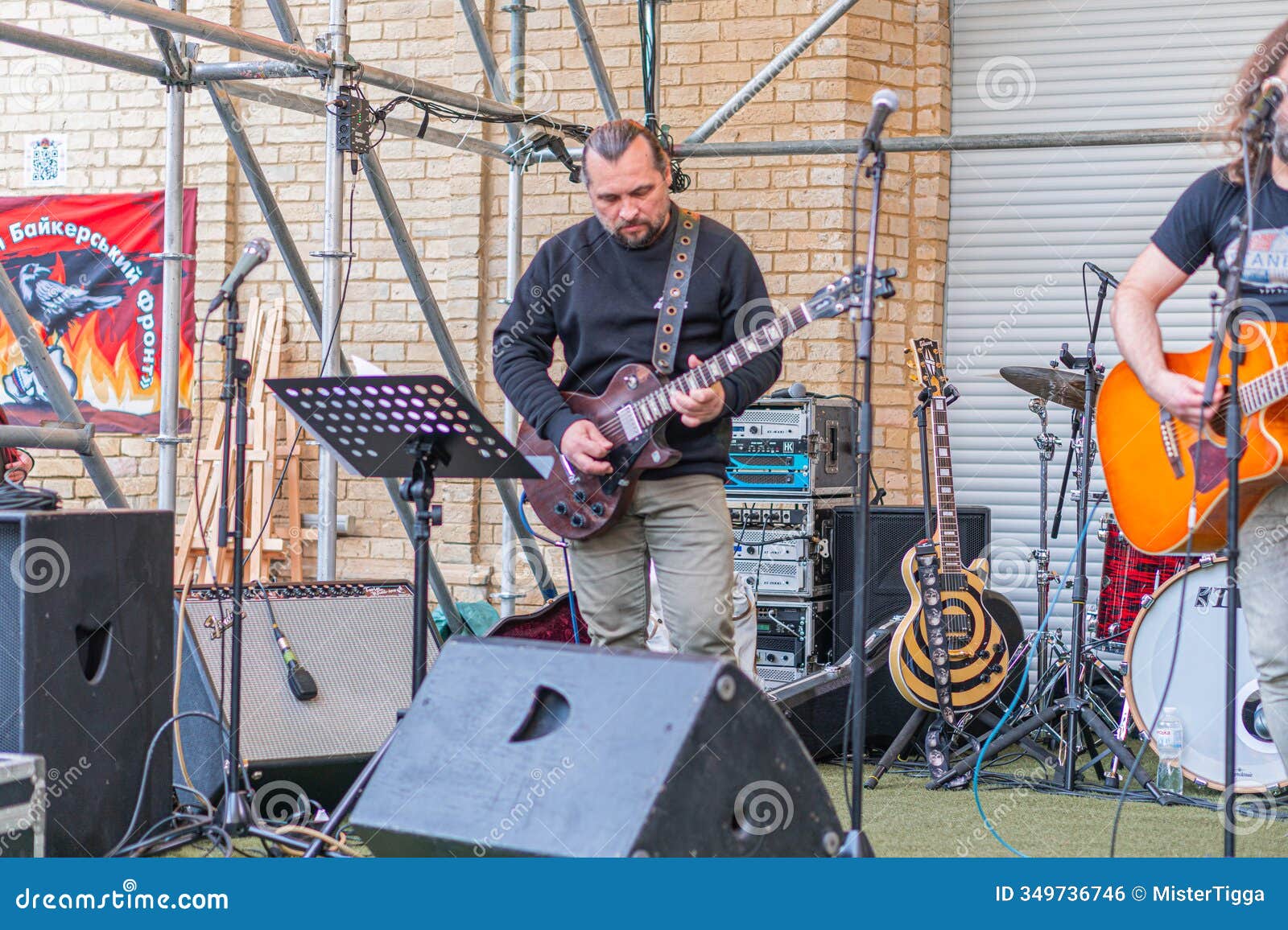 Two Individuals Performing on Stage, One Guitarist and One Singer ...