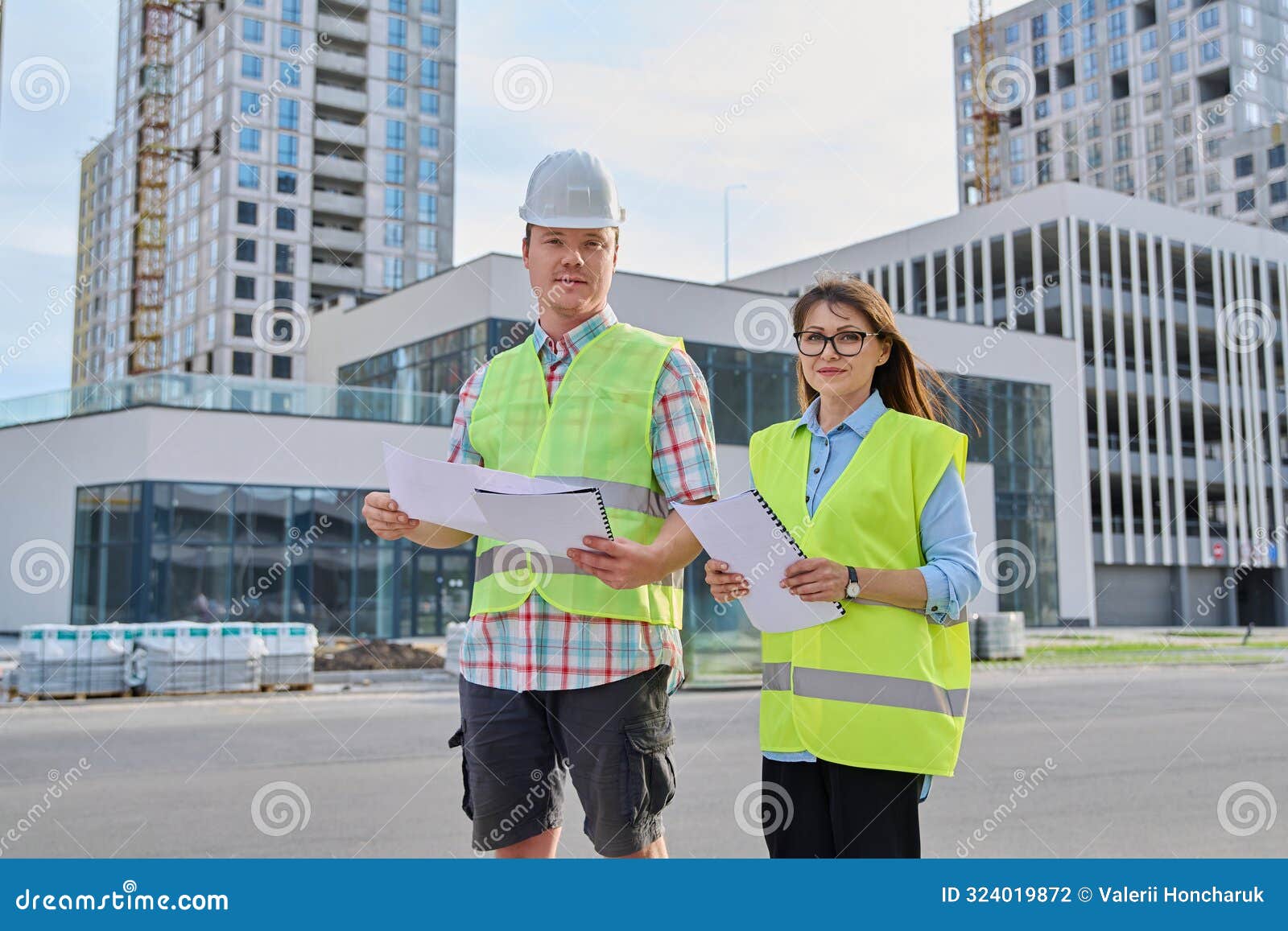 Two Industrial Construction Workers Discussing Project Plan for ...