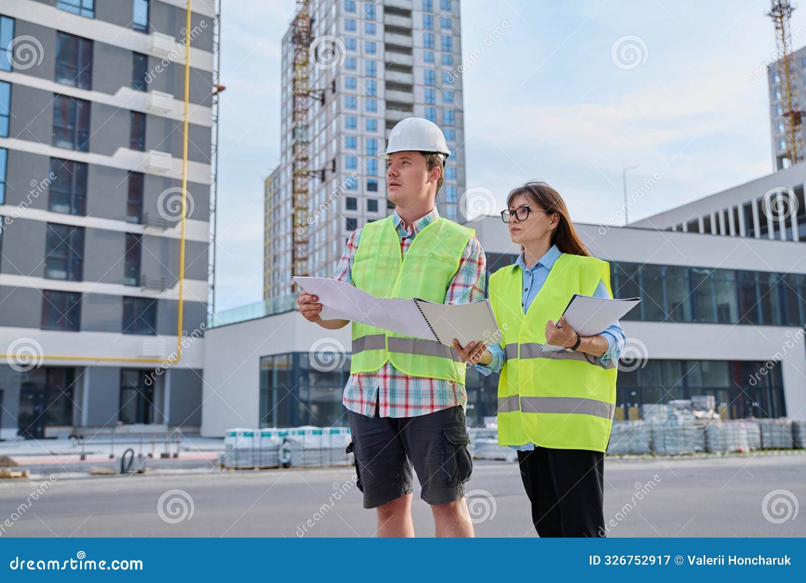 Two Industrial Construction Workers Discussing Project Plan for ...