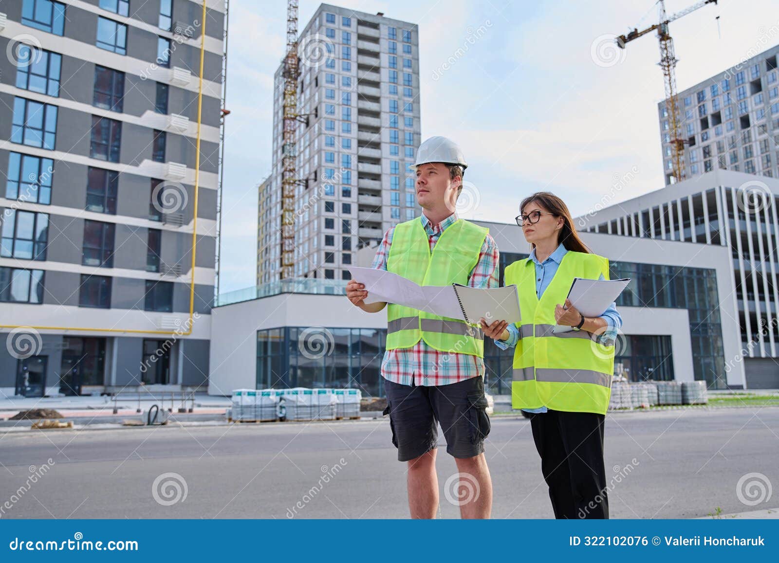 Two Industrial Construction Workers Discussing Project Plan for ...