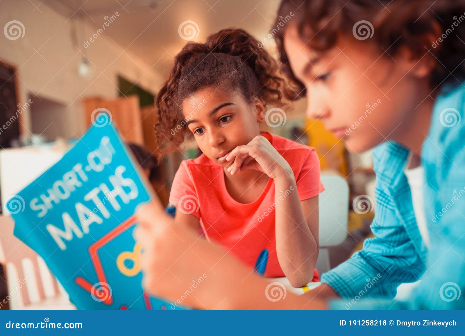 Two Interested Schoolchildren Reading a Math Textbook Stock Photo ...