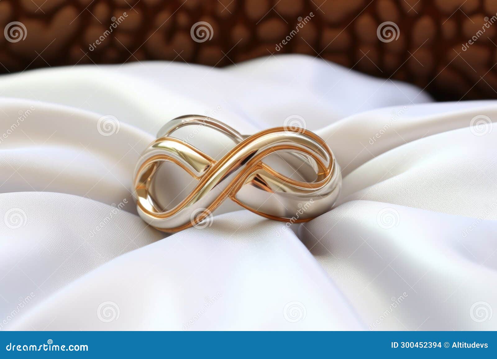 Two Intertwined Wedding Rings Forming an Infinity Sign on a White ...