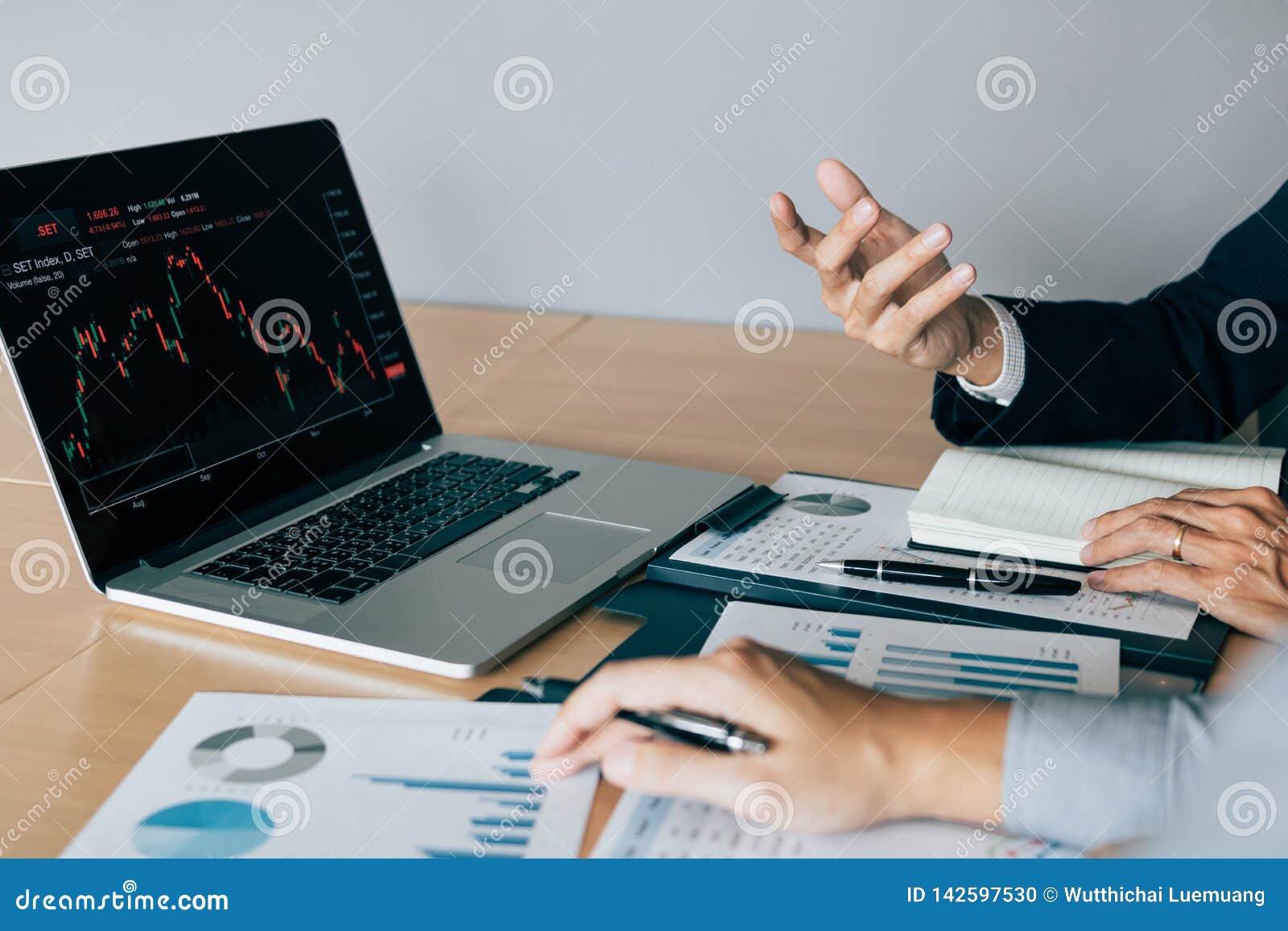 Two Investors Working Together are Analyzing the Stock Chart on the ...