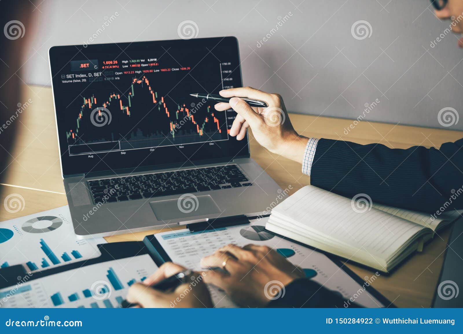 Two Investors Working Together are Analyzing the Stock Chart on the ...