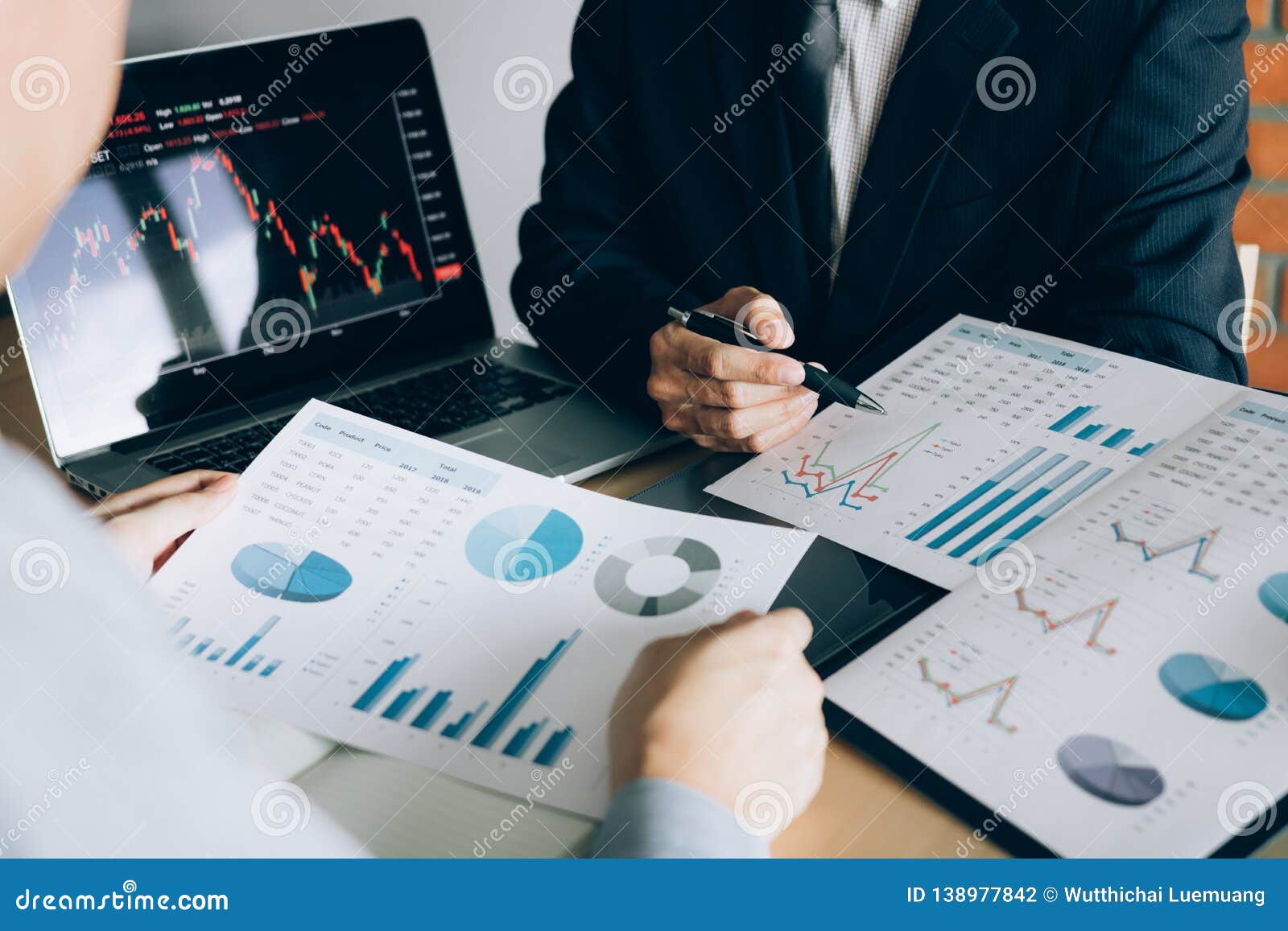 Two Investors are Working Together with Analyzing the Stock Data Graphs ...