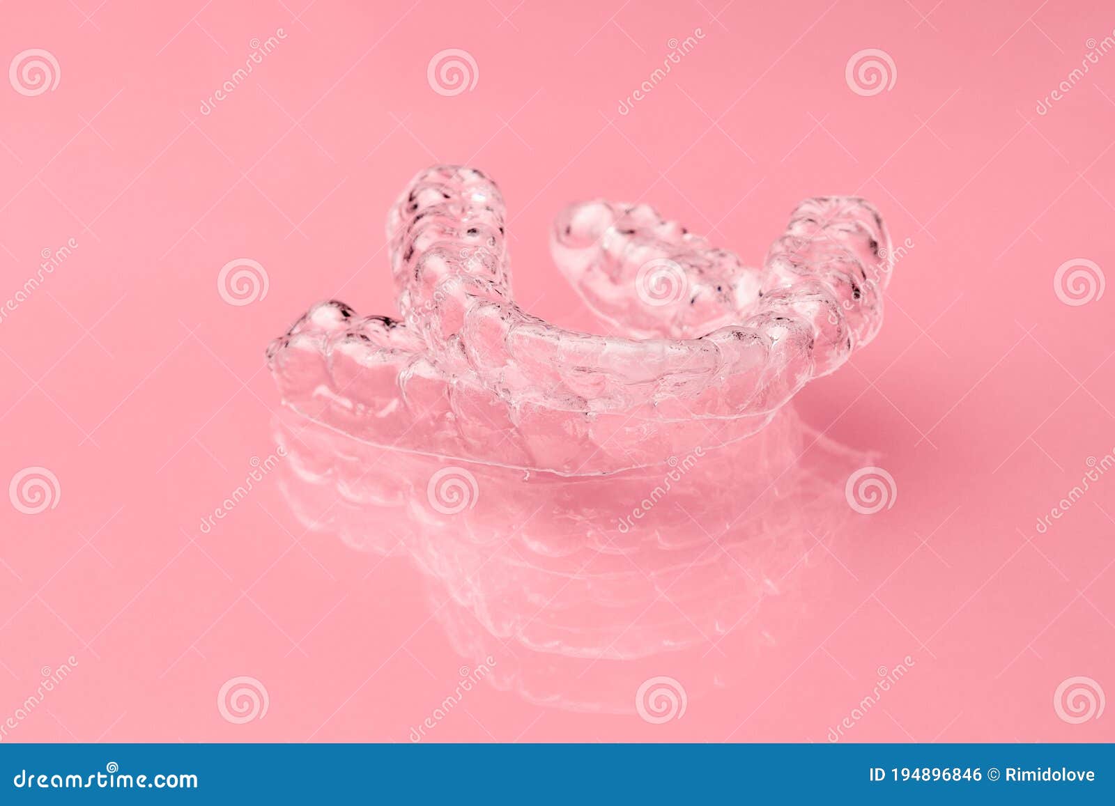 Two Invisible Dental Teeth Aligners on the Pink Background. Orthodontic ...