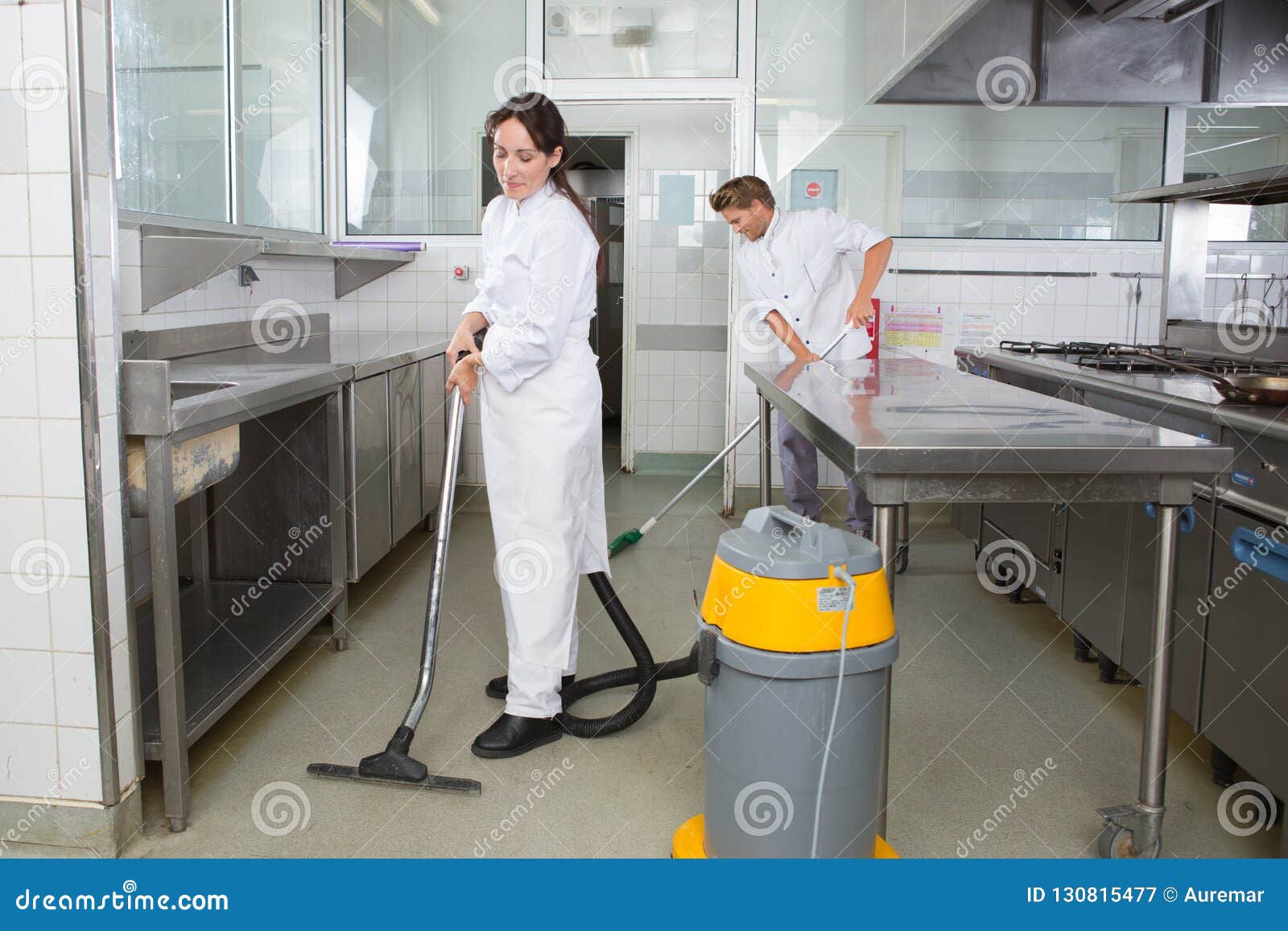 Two Janitor Cleaning Kitchen Sink with Spray and Sponge Stock Image ...