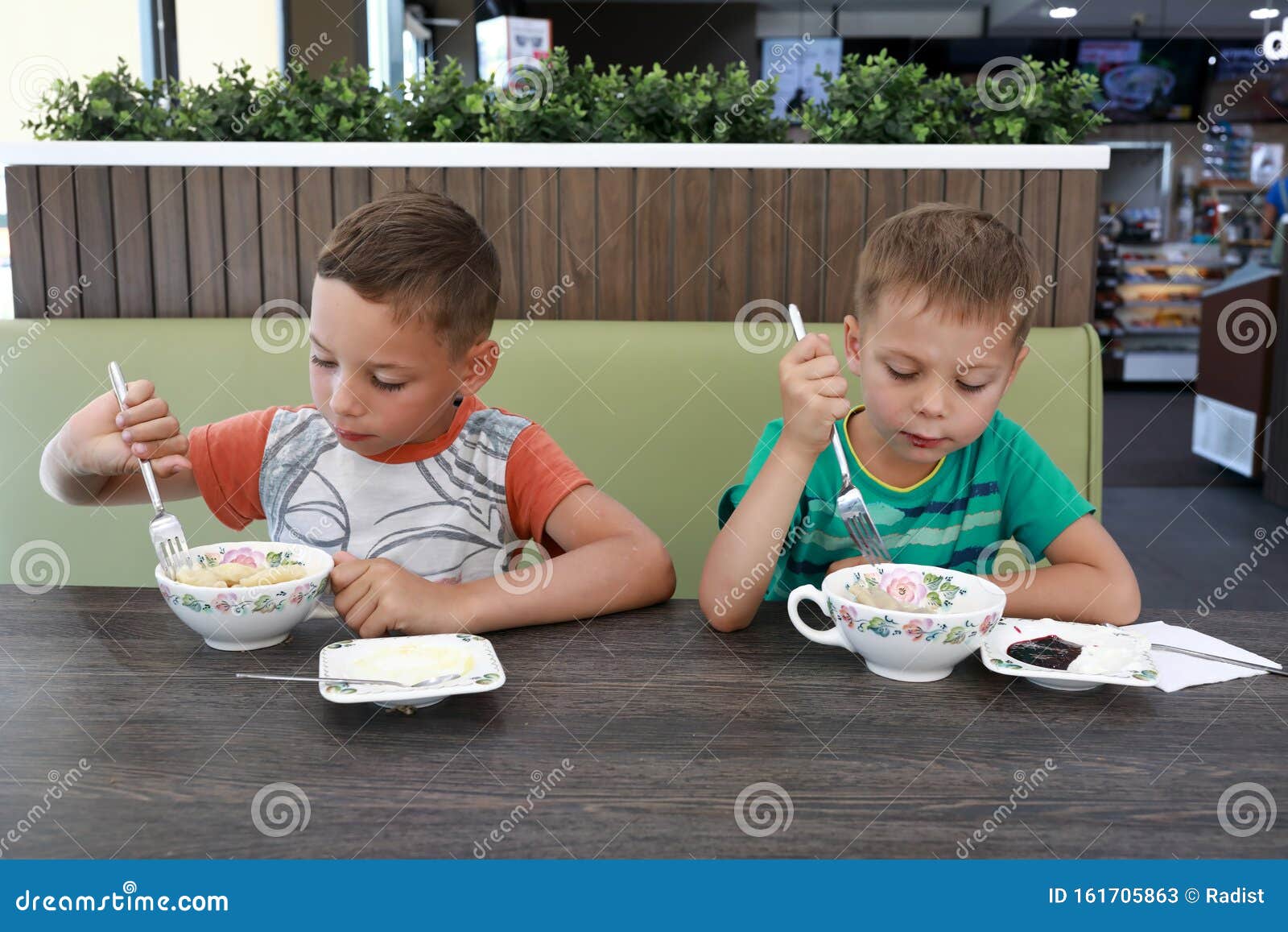 Two kids eating Dumplings stock image. Image of dumpling - 161705863