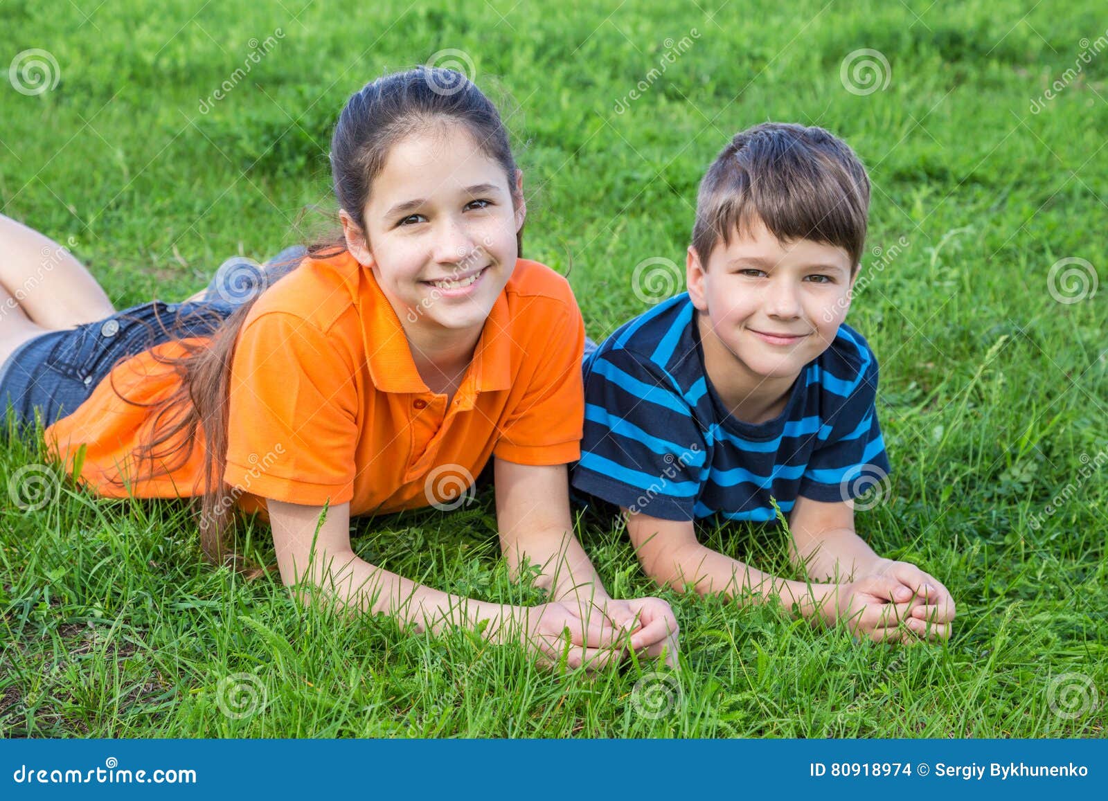 Two kids on green lawn stock photo. Image of child, sibling - 80918974