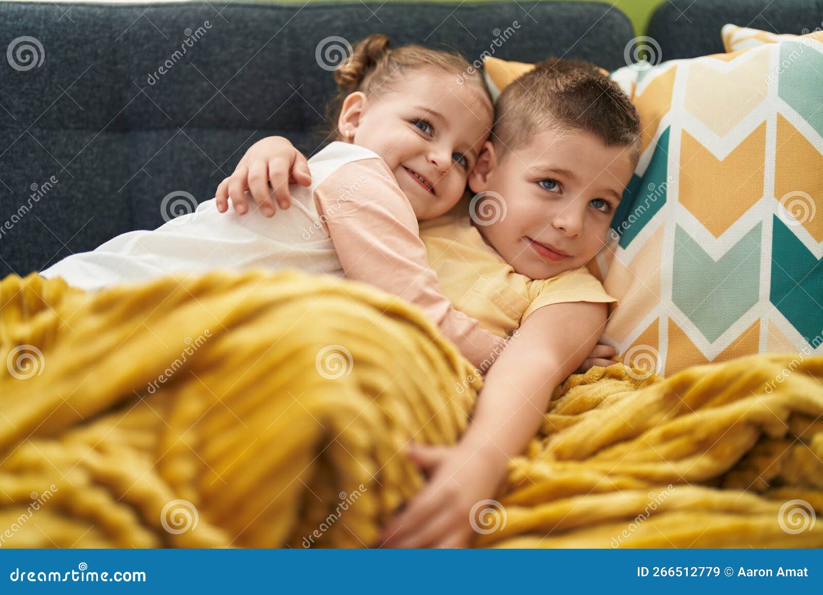 Two Kids Hugging Each Other Lying on Sofa at Home Stock Image - Image ...