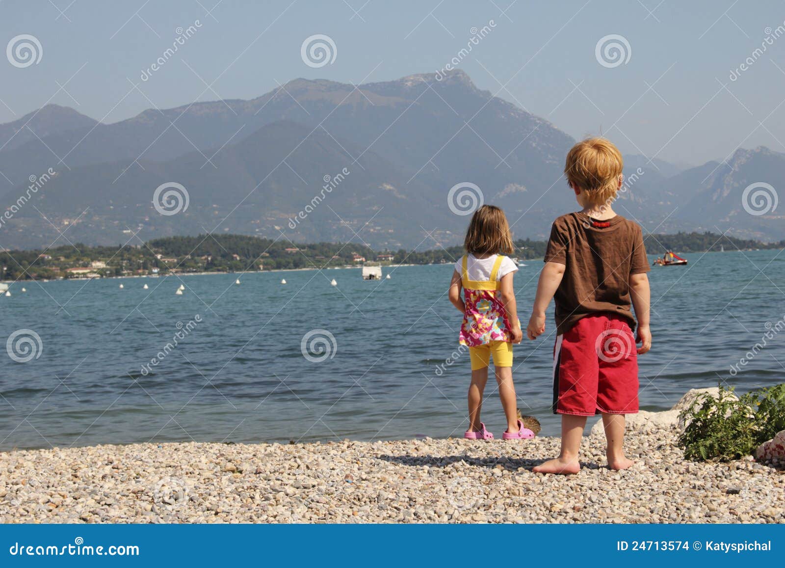 Two kids looking at a lake stock photo. Image of look - 24713574