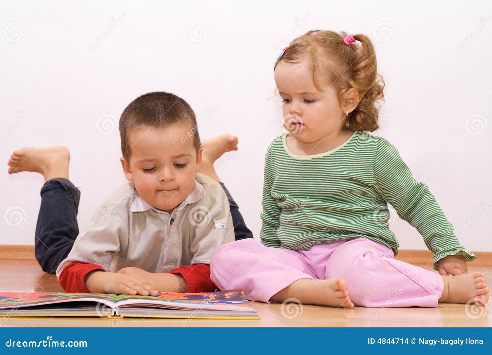 Two Kids Looking at the Tale Book Stock Photo - Image of family, book ...