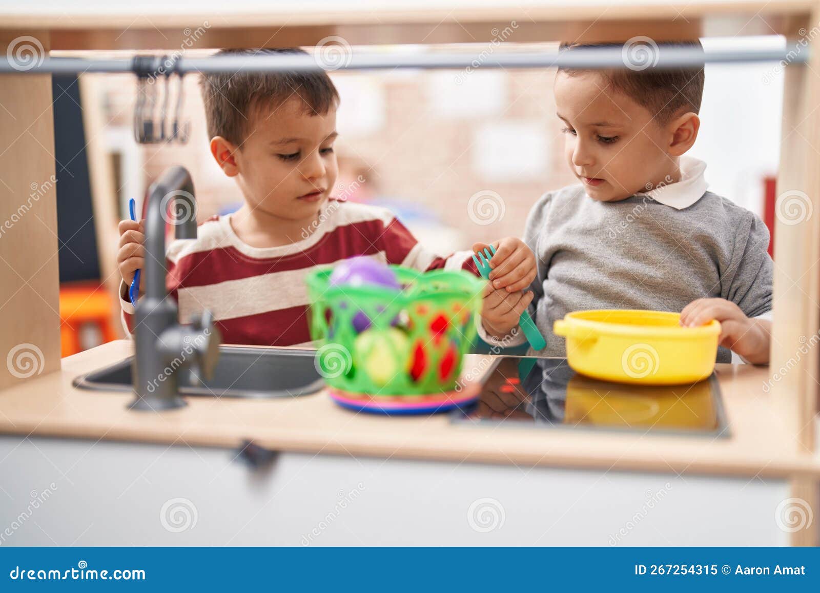 Two Kids Playing with Play Kitchen Standing at Kindergarten Stock Image ...